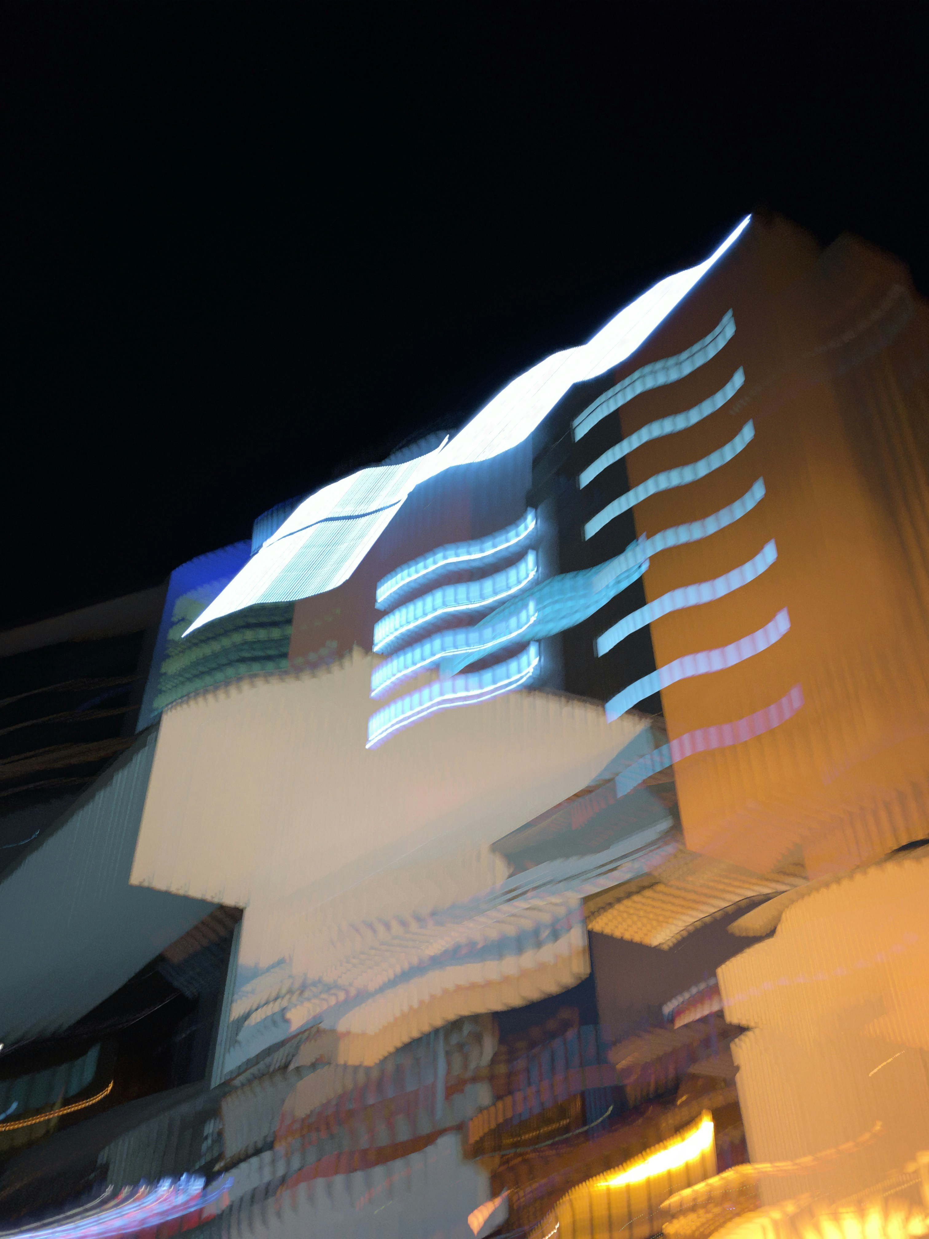 Ribboned Neon: Night Facades in Motion