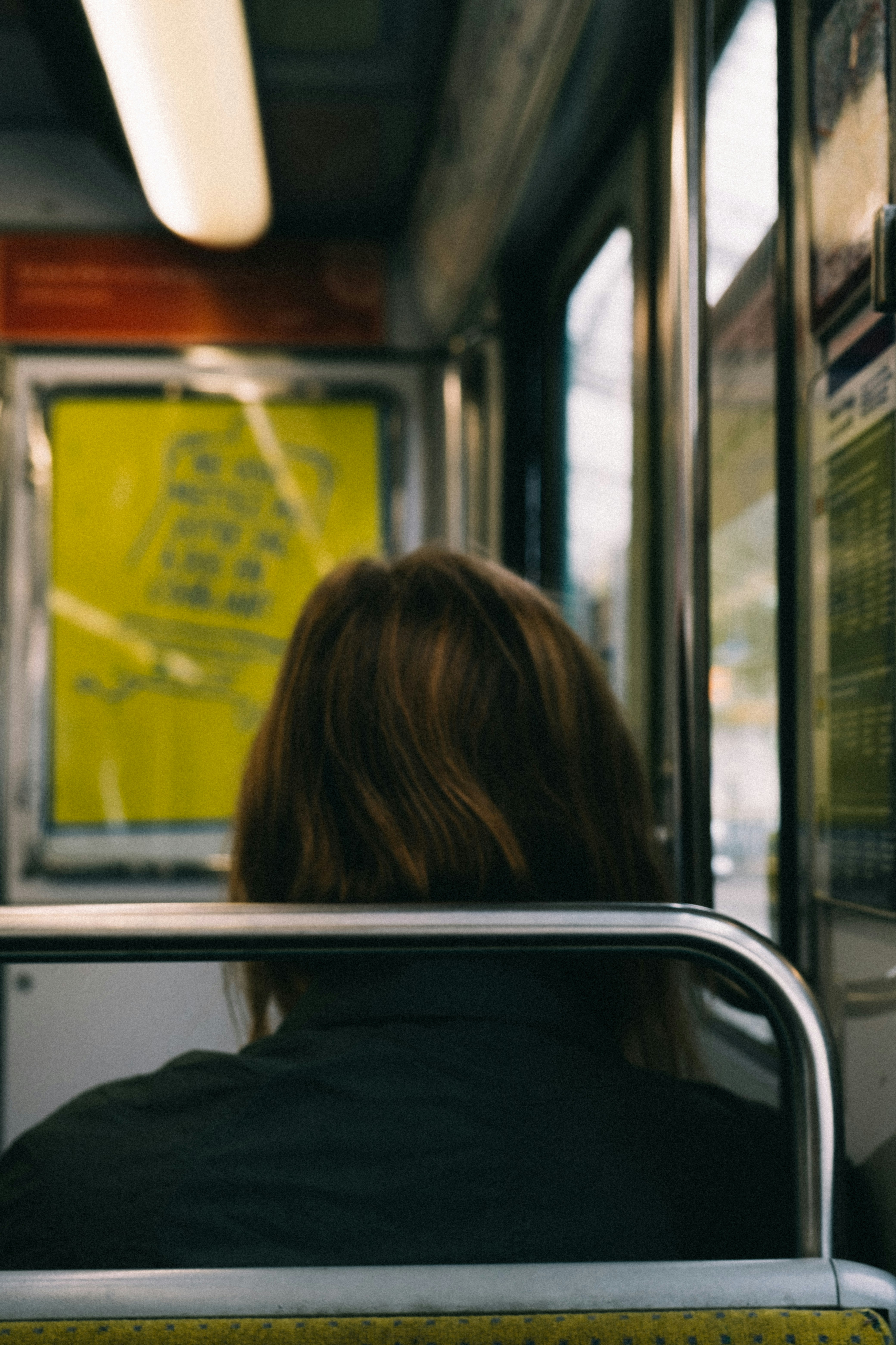 A woman sitting on a bus looking out the window photo – Free France ...