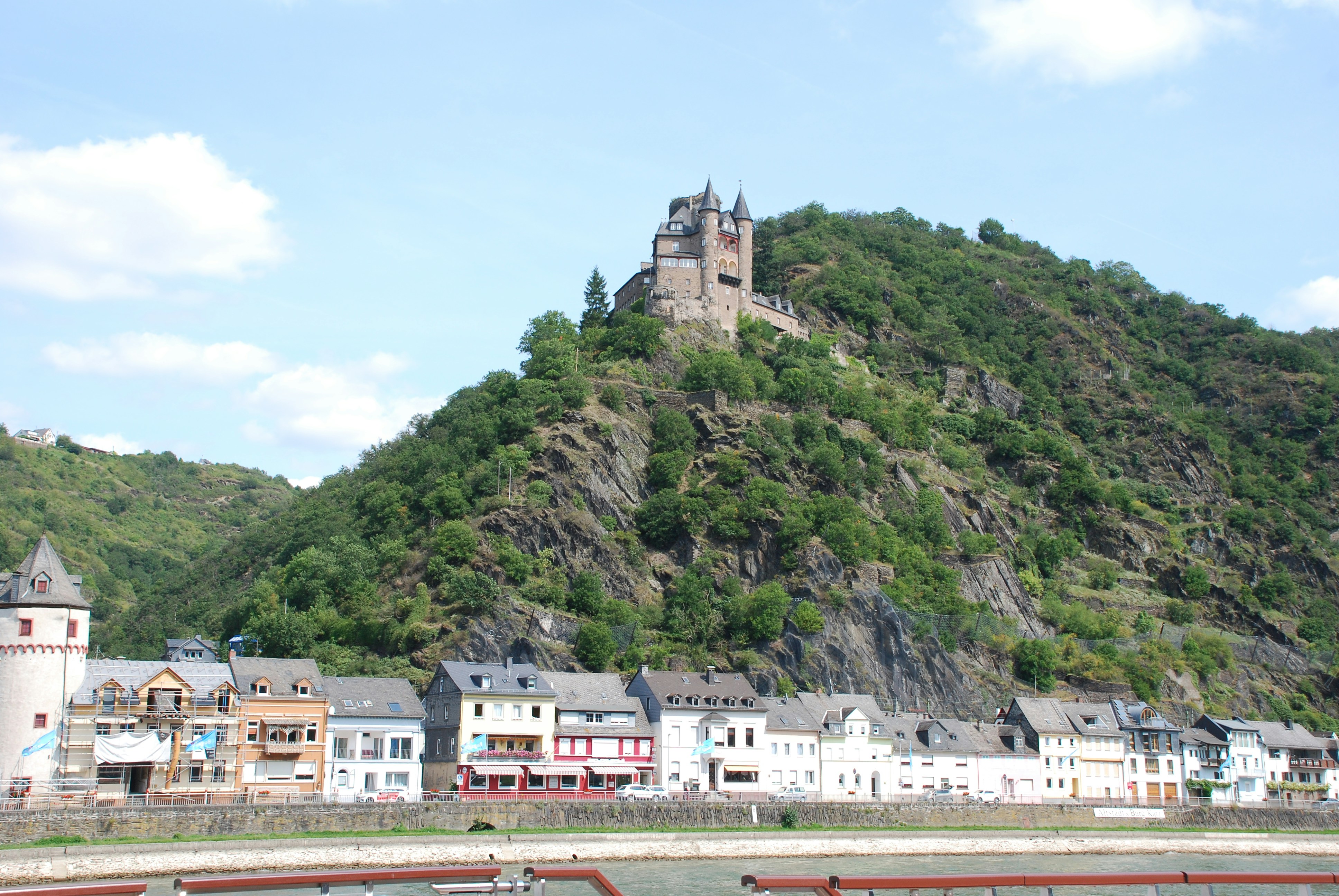 Castle Crest Above the Riverside Village: A Hilltop Fortress Overlooking the Waterfront