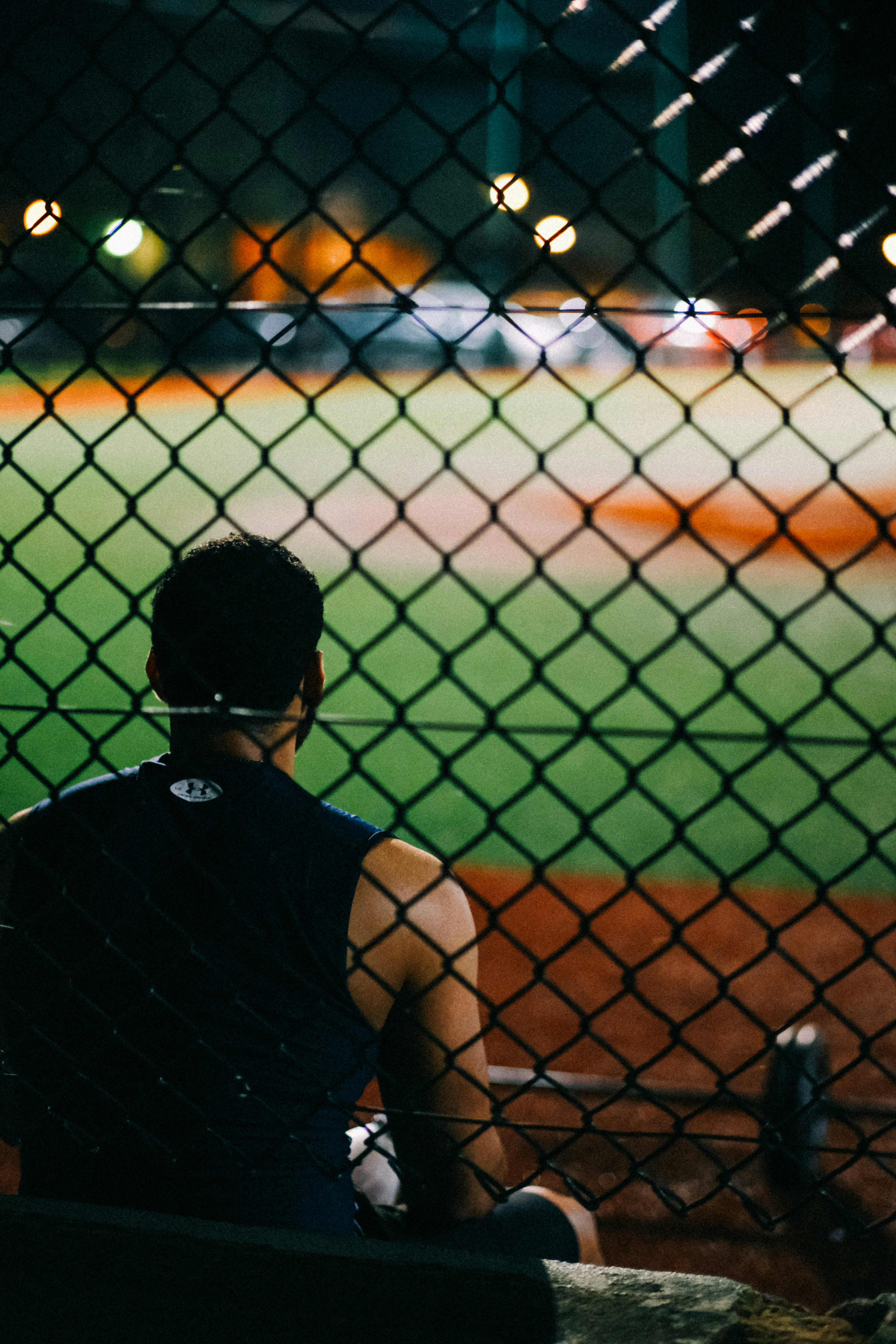 A man sitting on a bench watching a baseball game photo – Free Terrain ...