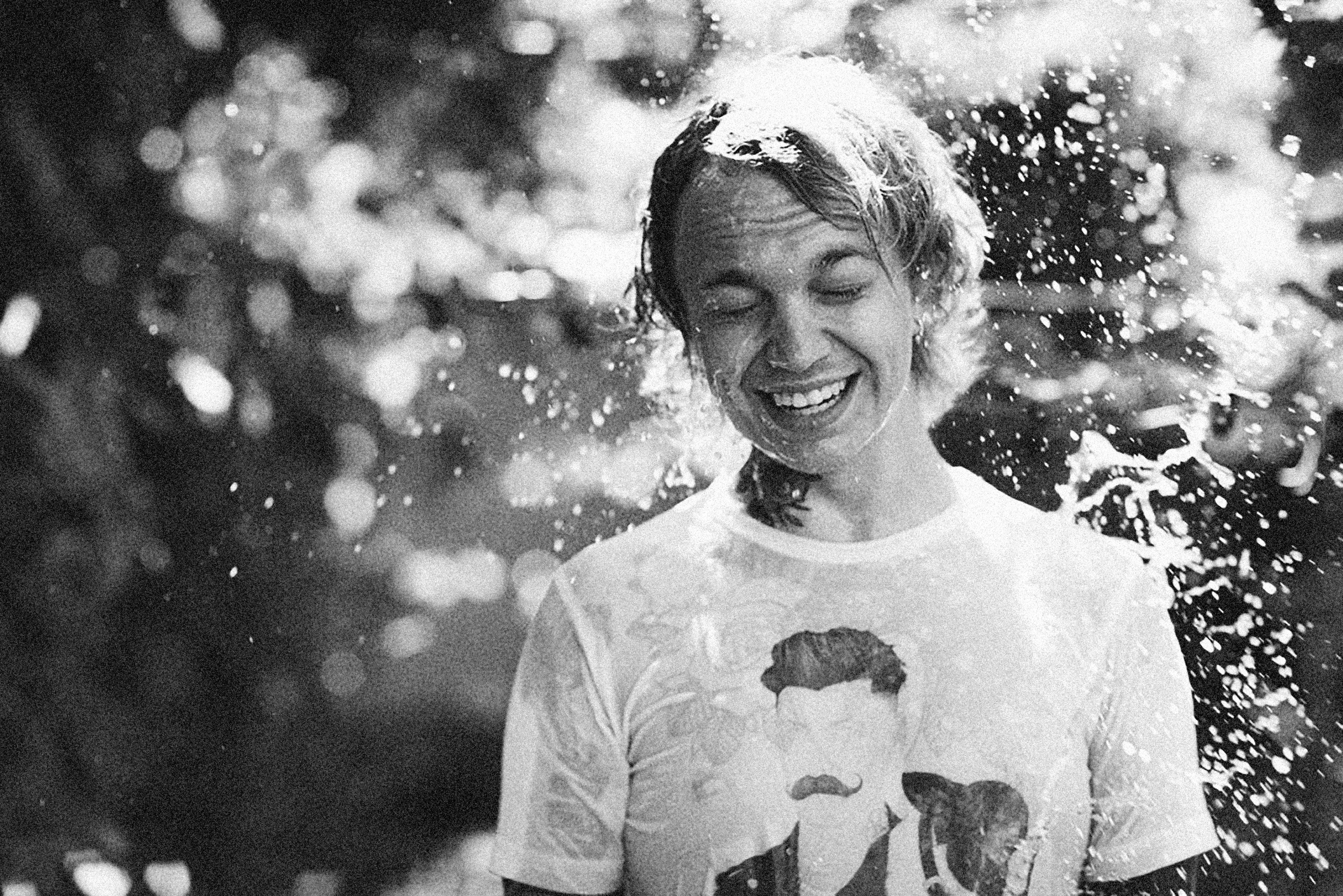 A woman is sprinkling water on her face photo – Free Smile Image on ...