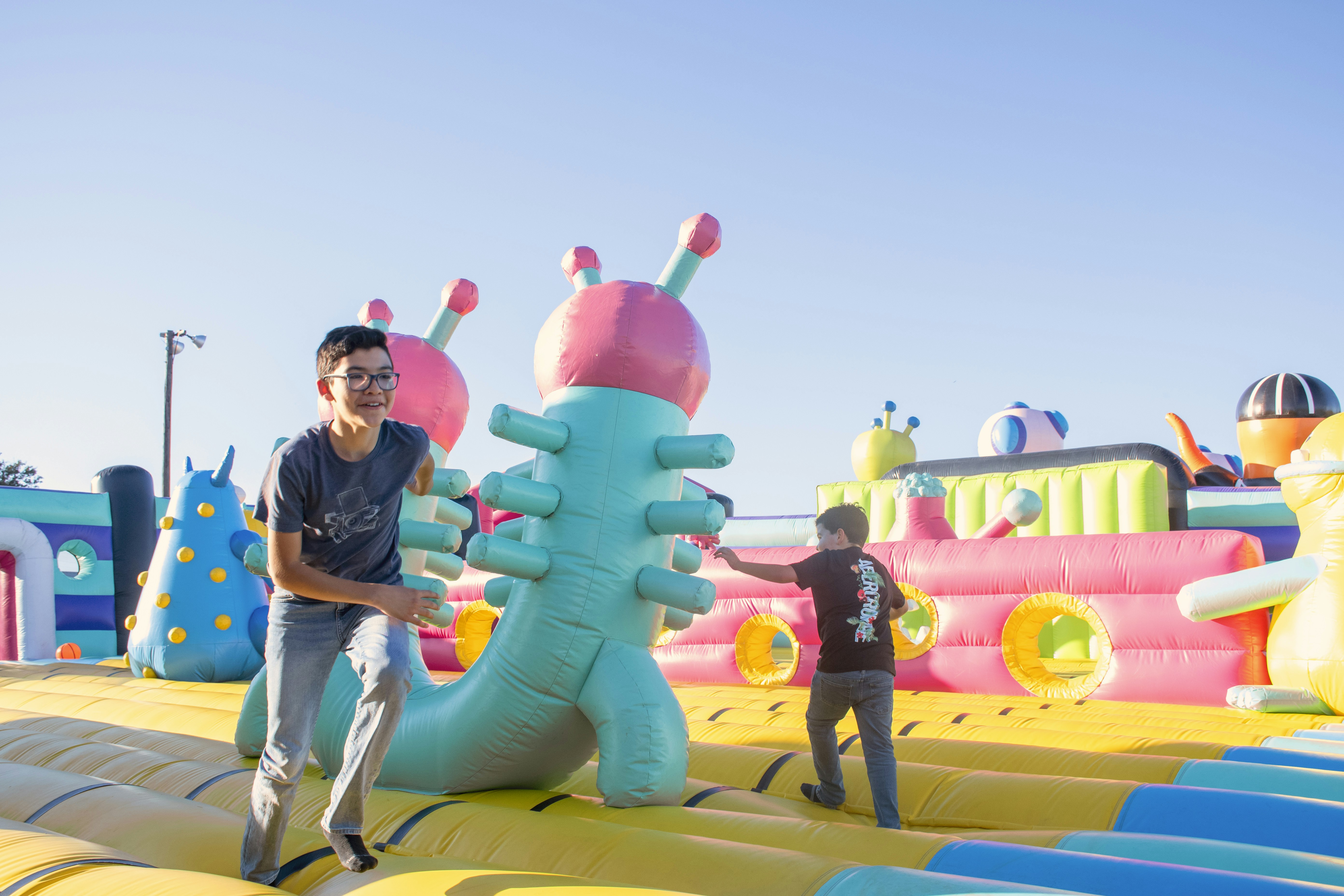 A man standing next to a giant inflatable alien photo – Free Person ...