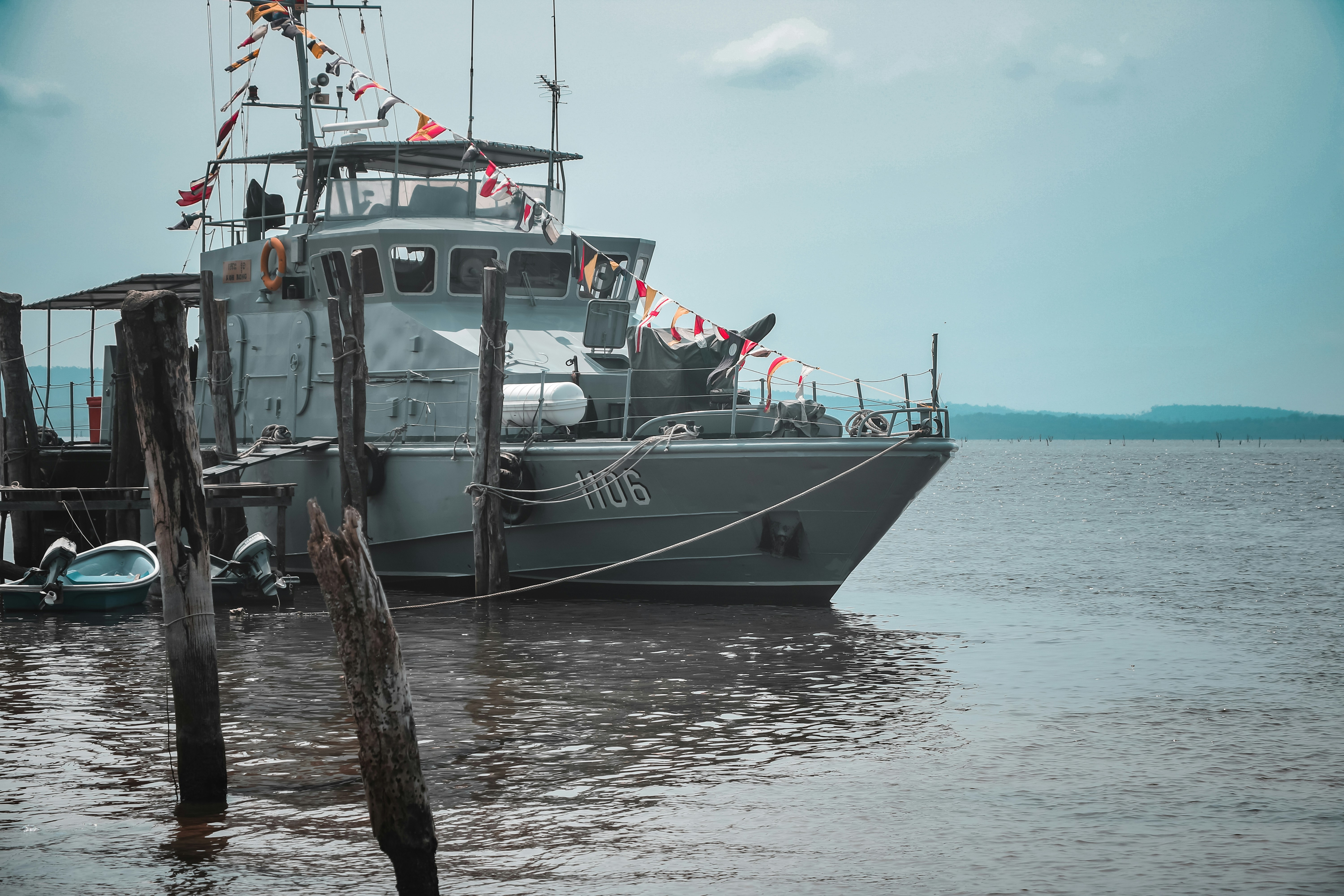 Decorated vessel moored at calm shoreline
