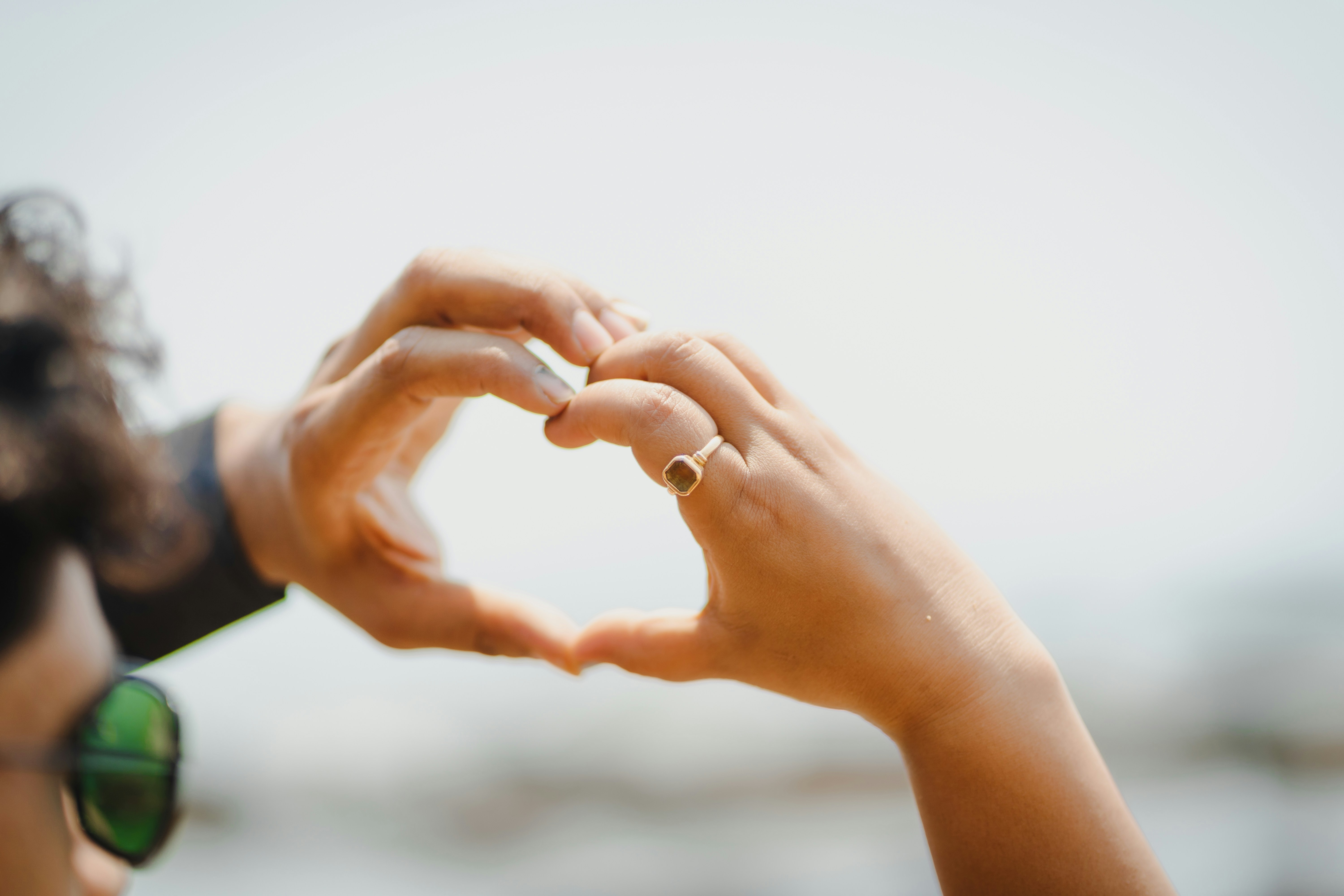 A woman making a heart shape with her hands photo – Free Love Image on ...