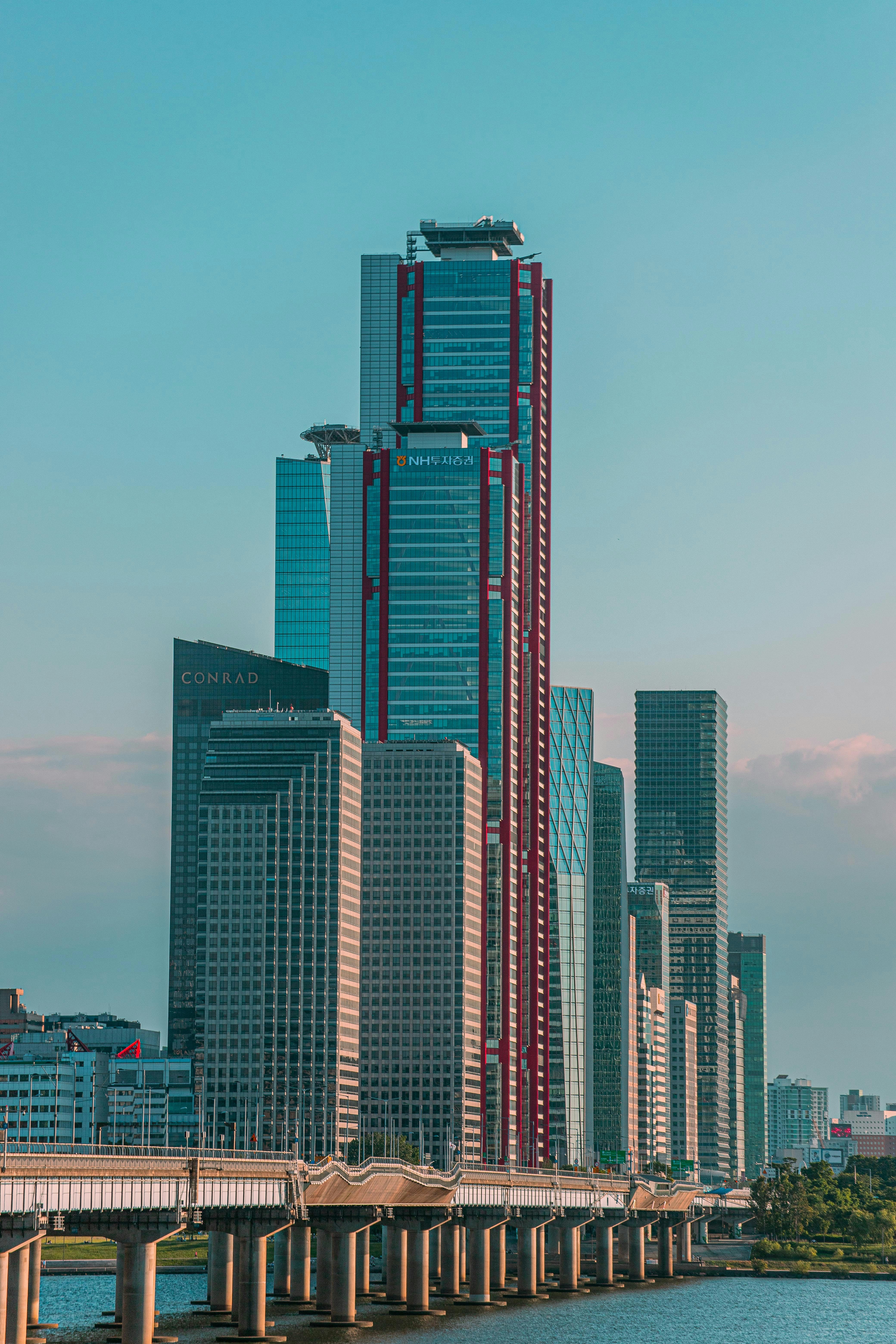 Red-Accented Skyline: Towering Glass Meets a Bridge