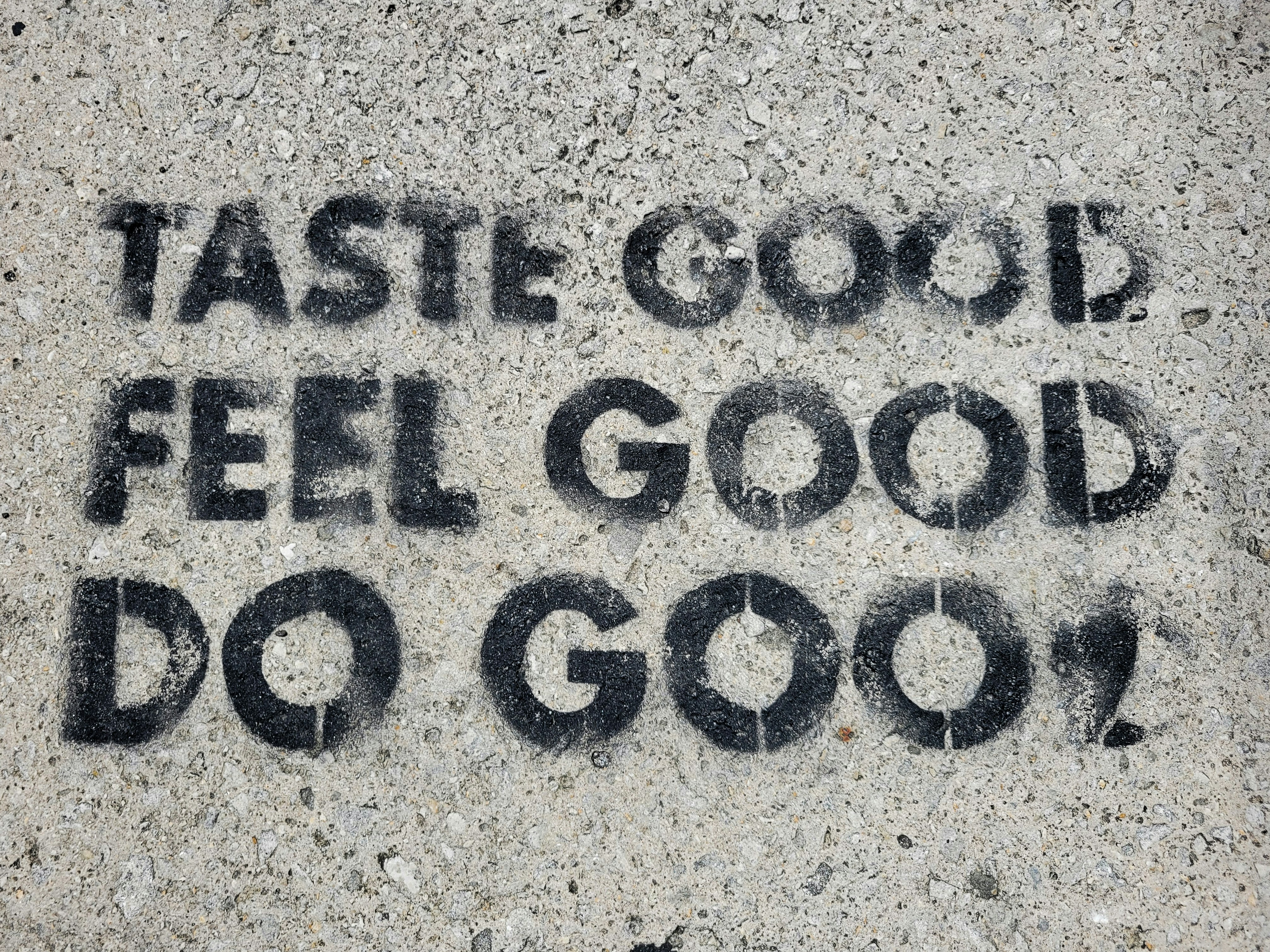 The words taste good, feel good, do good written in black ink on a ...