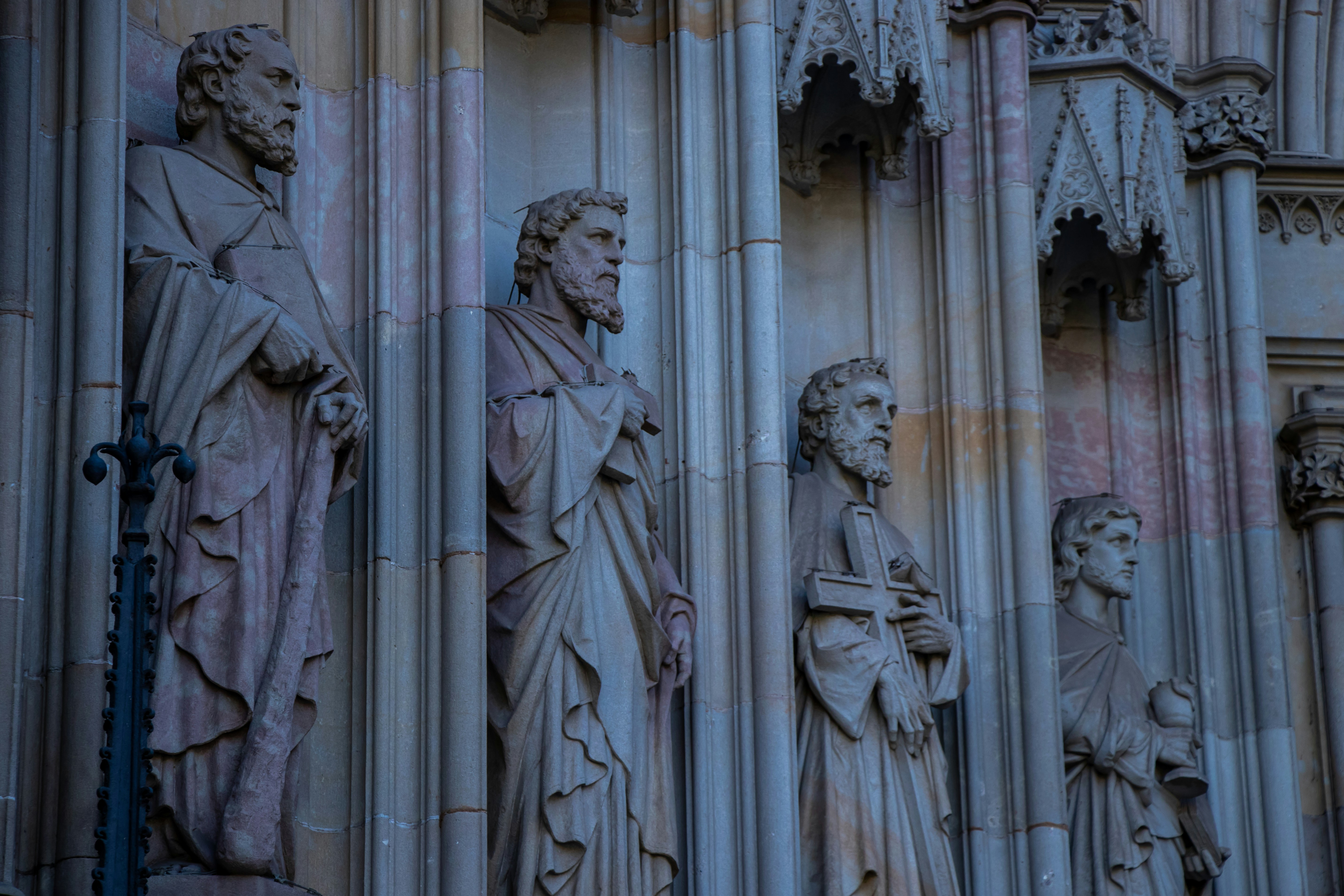 Cobalt Sentinels: Statues Guarding a Gothic Facade
