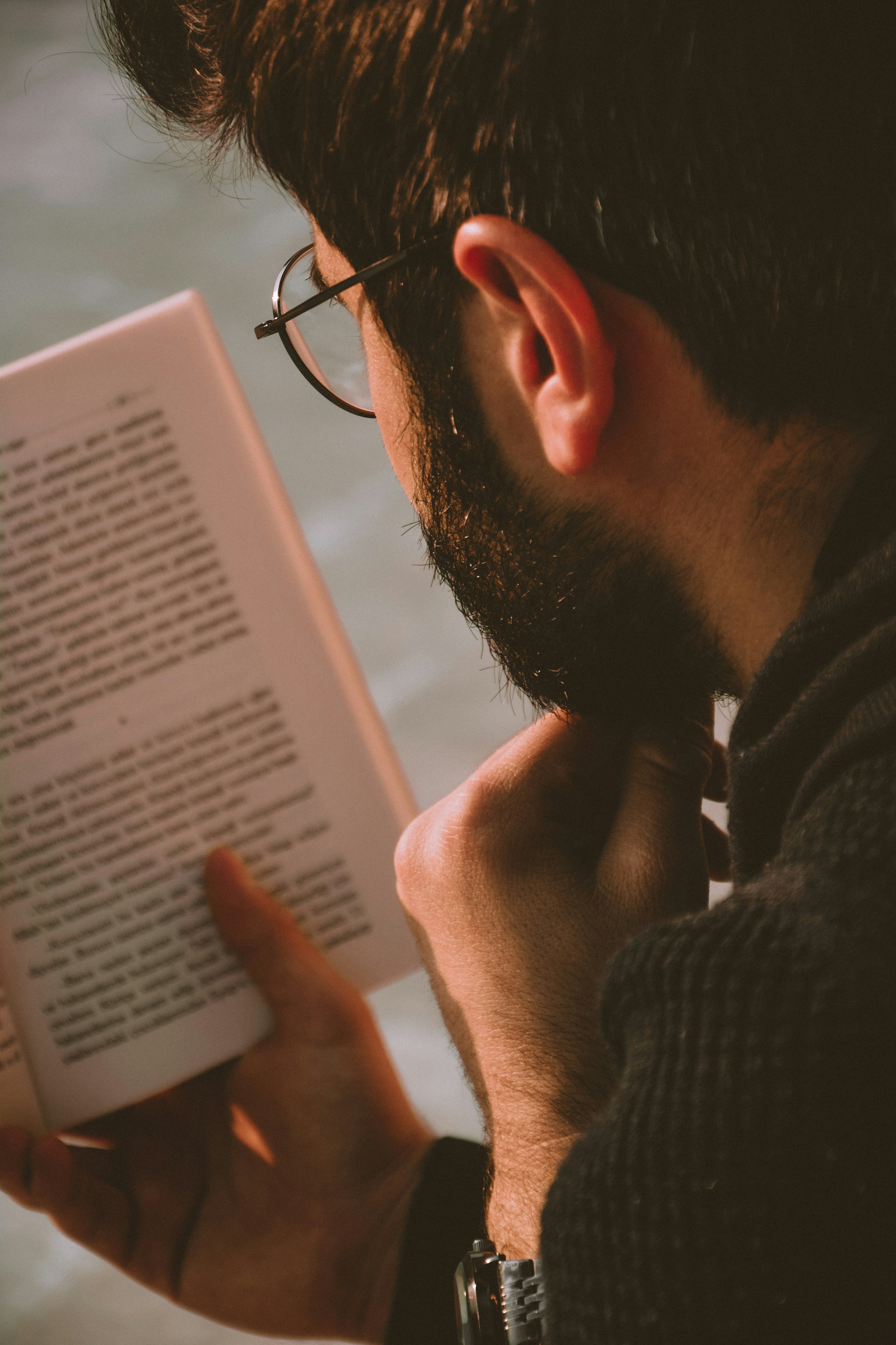 A man with glasses reading a book photo – Free Face Image on Unsplash