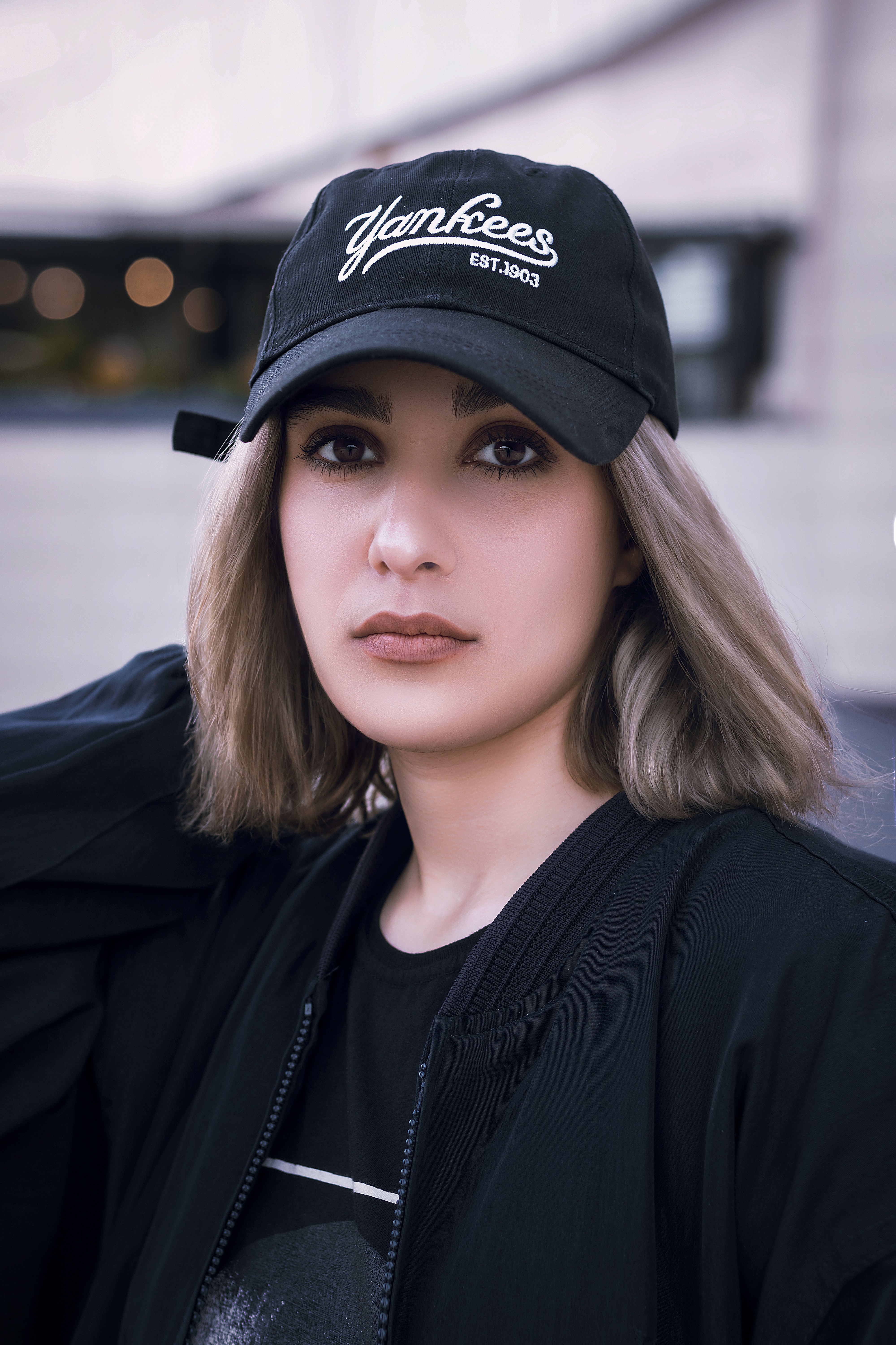 Cap and Confidence: A Portrait in Soft Street Light