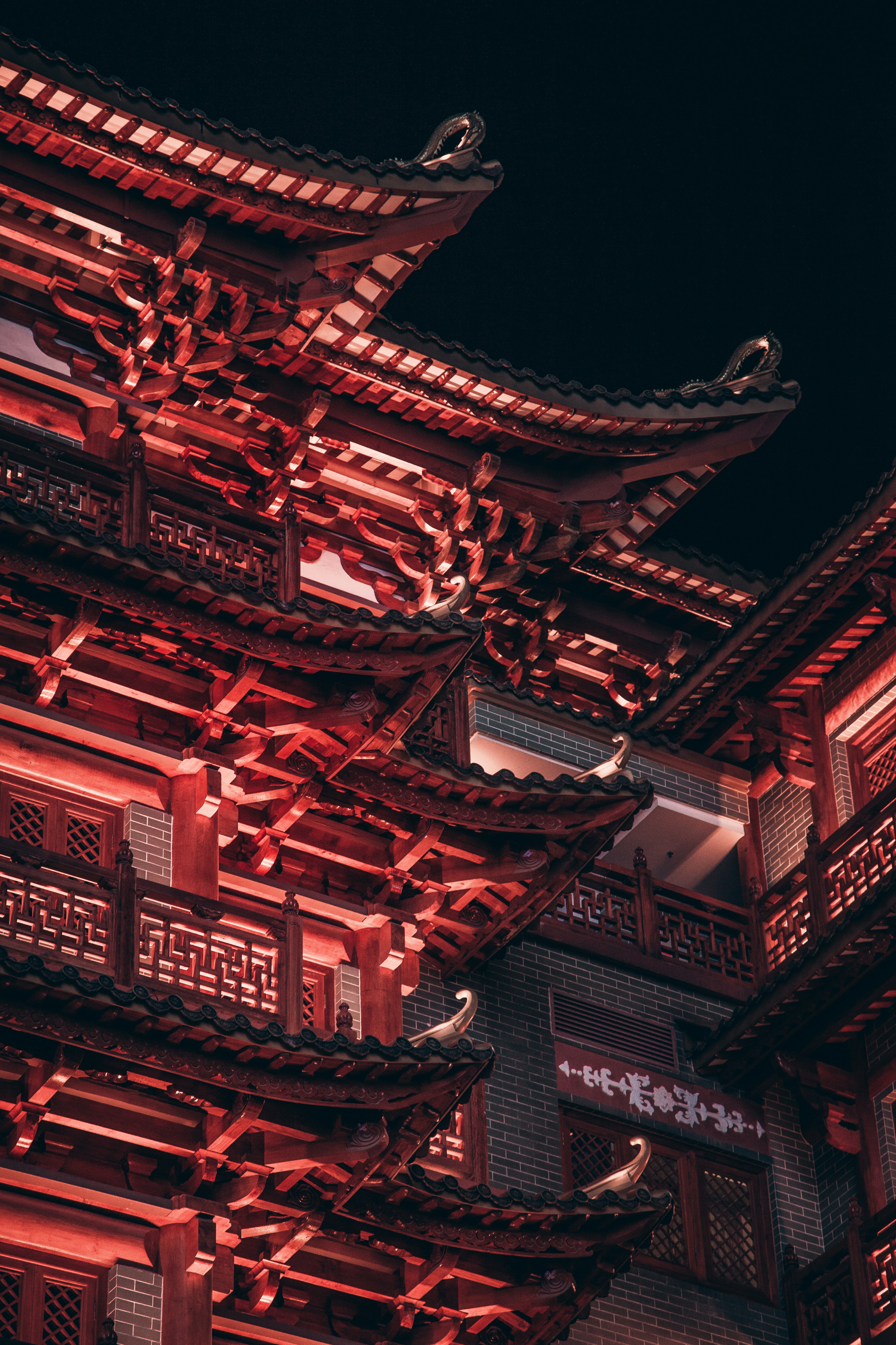 A tall building with red lights on top of it photo – Free Temple Image ...