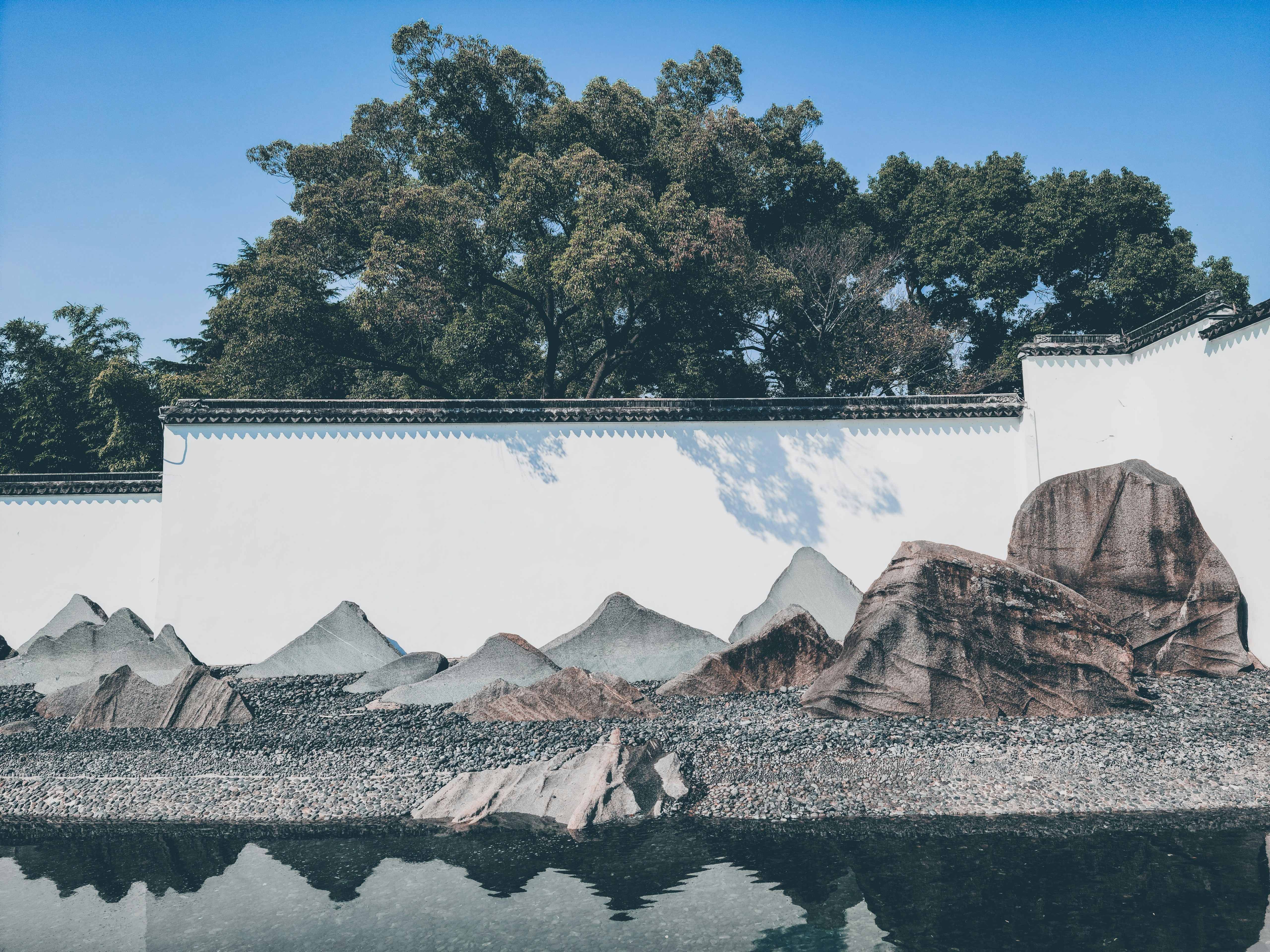 a large rock sitting in the middle of a body of water