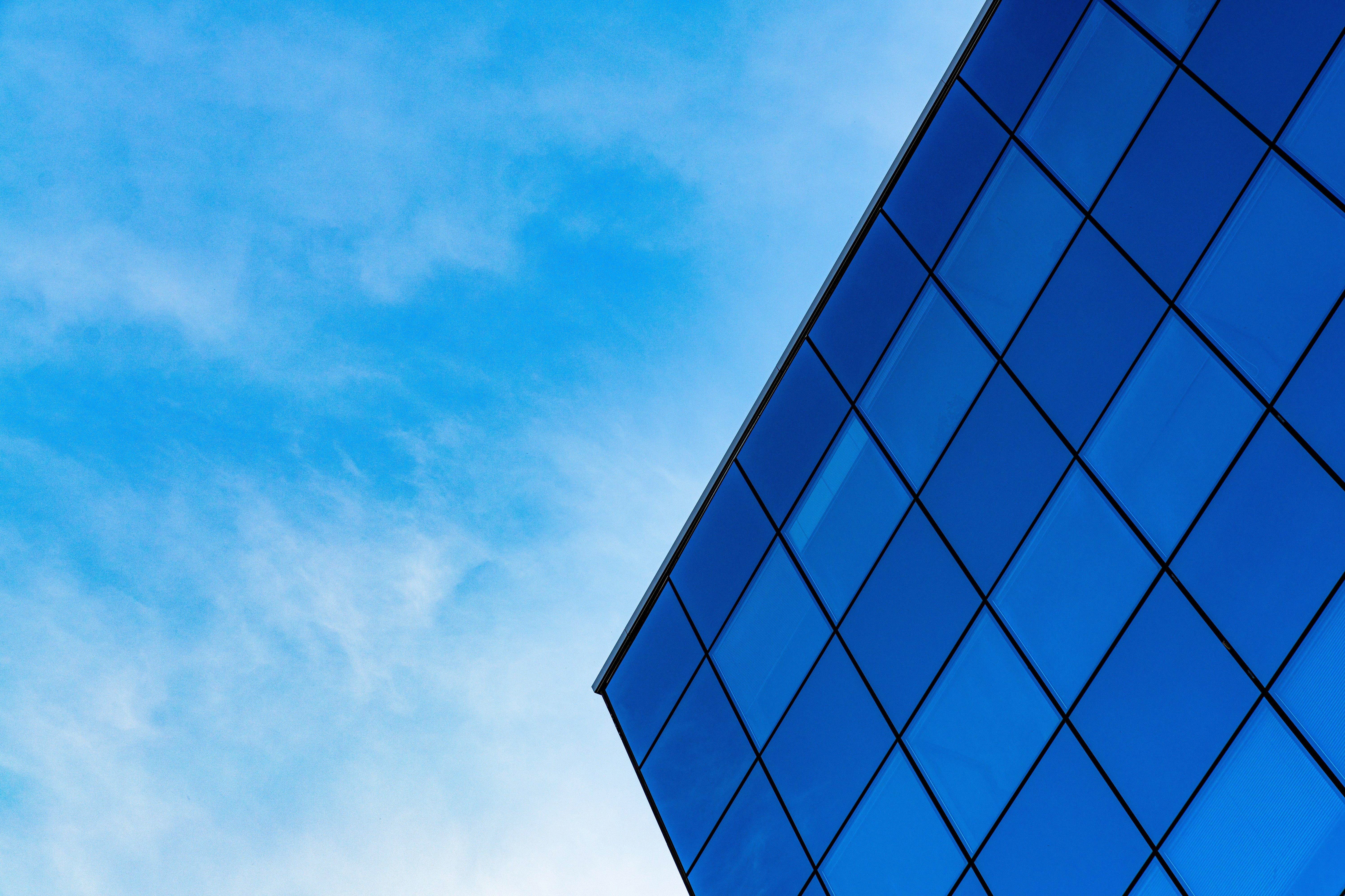 Un bâtiment bleu avec un avion volant dans le ciel photo – Photo Bleu ...