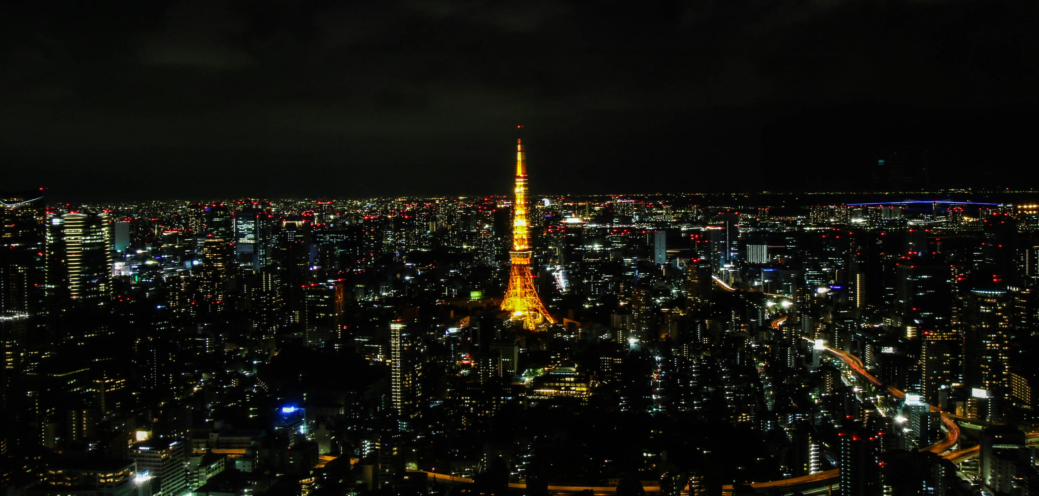 Tokyo Tower glowing amidst a sea of city lights at night, showcasing the vibrant urban landscape.