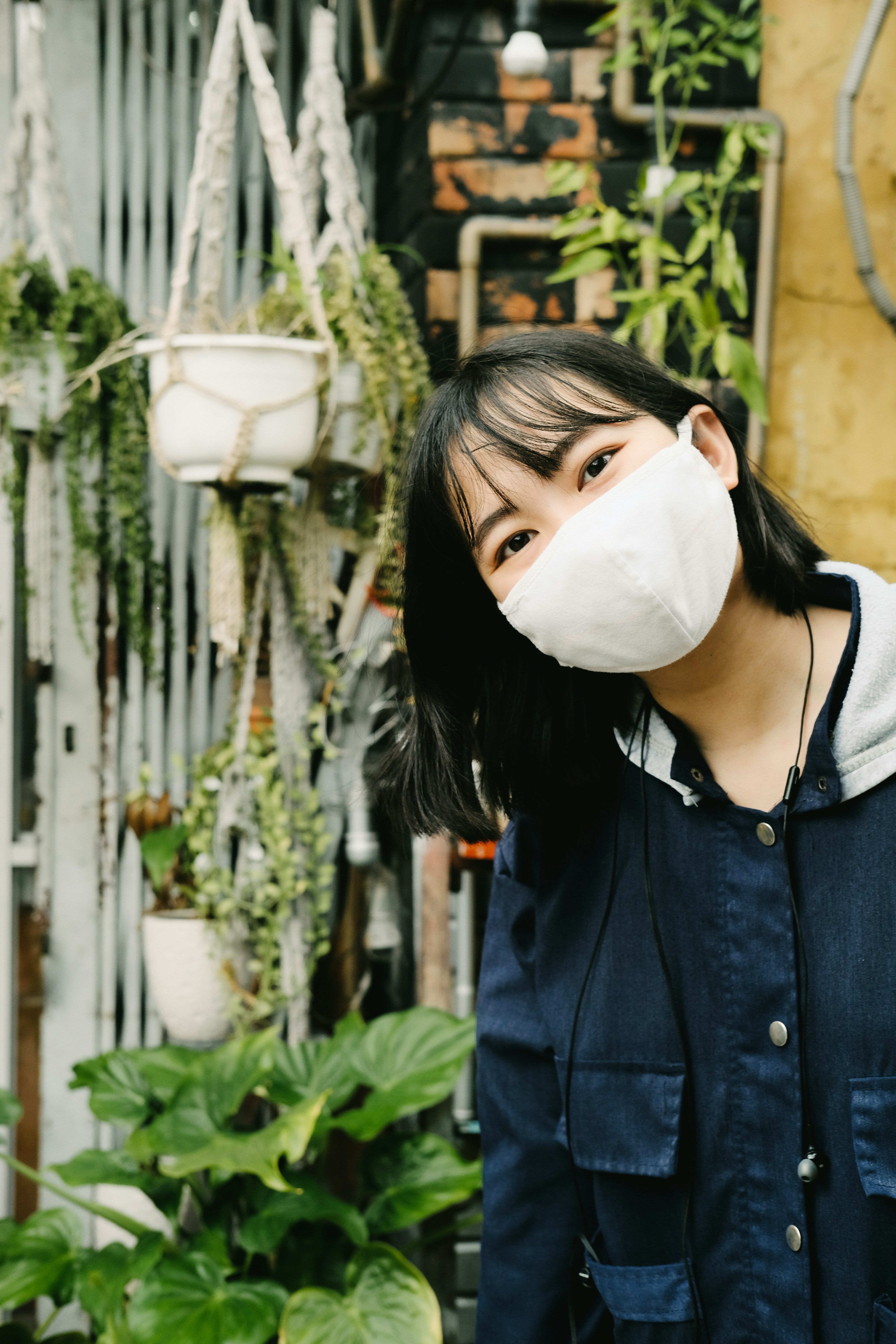 A woman wearing a face mask in a greenhouse photo – Free Jar Image on ...