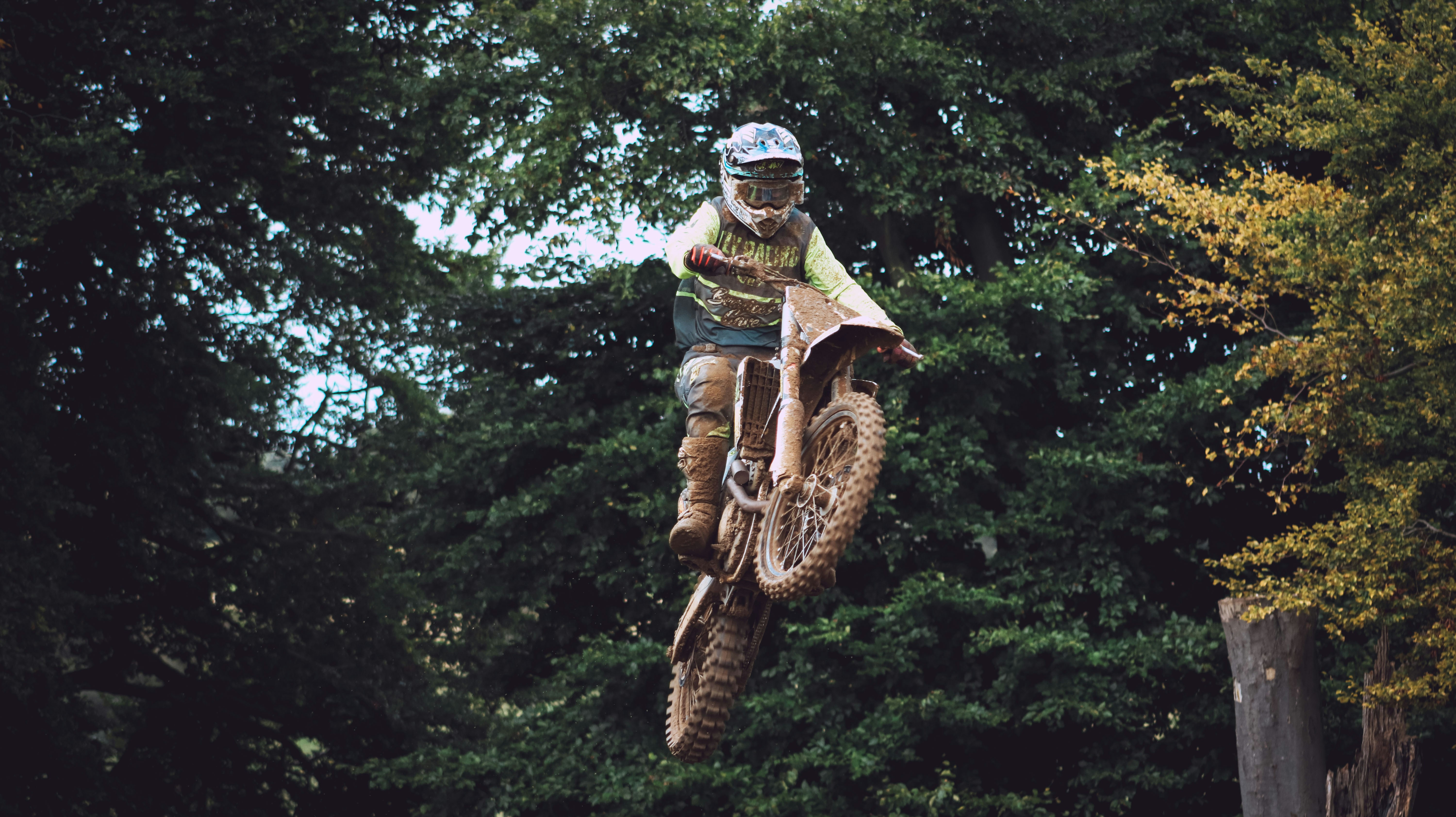 Airborne in the Pines: Dirt Bike Clears a Forest Jump