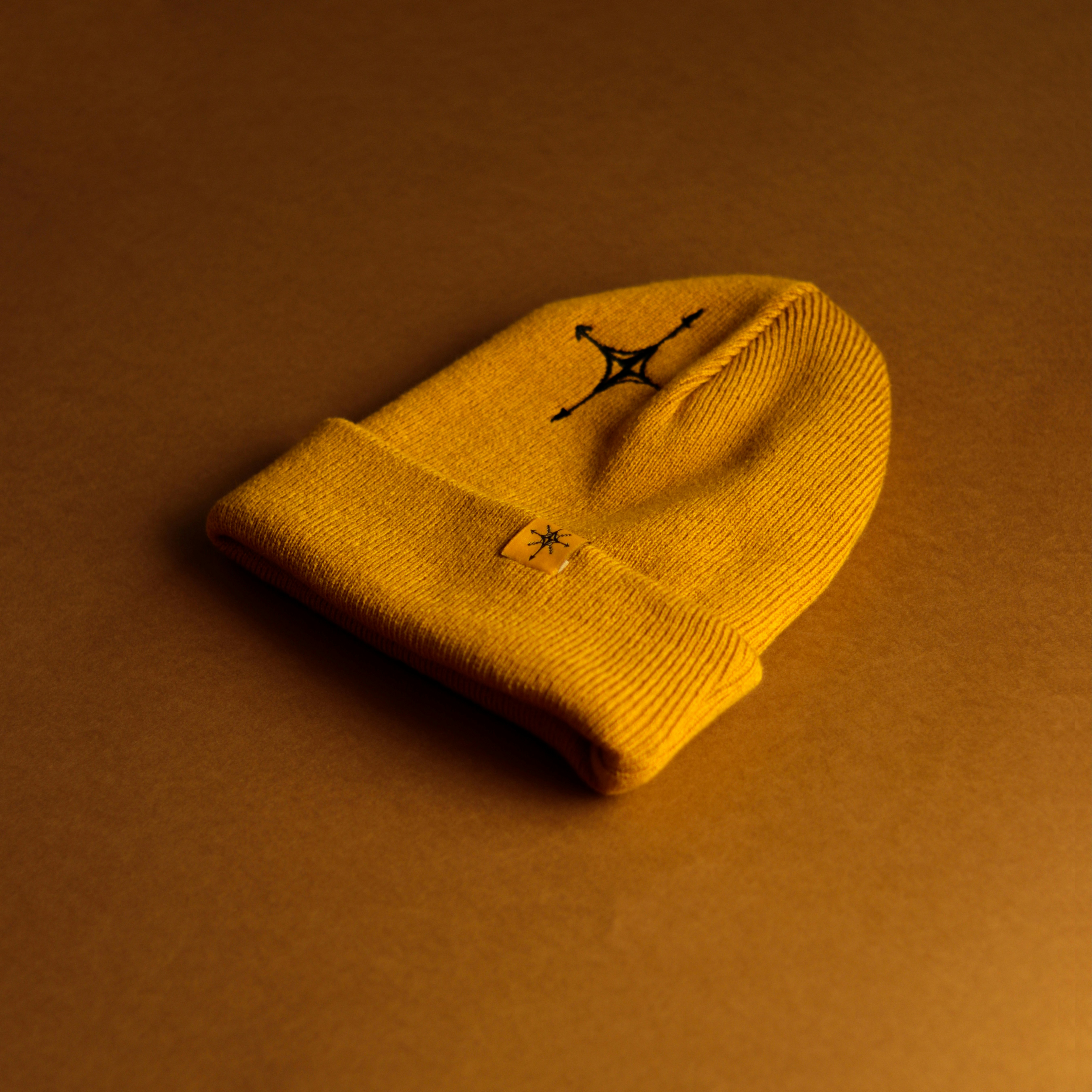 A yellow cap with a black star on it photo – Free Winter hat Image on ...