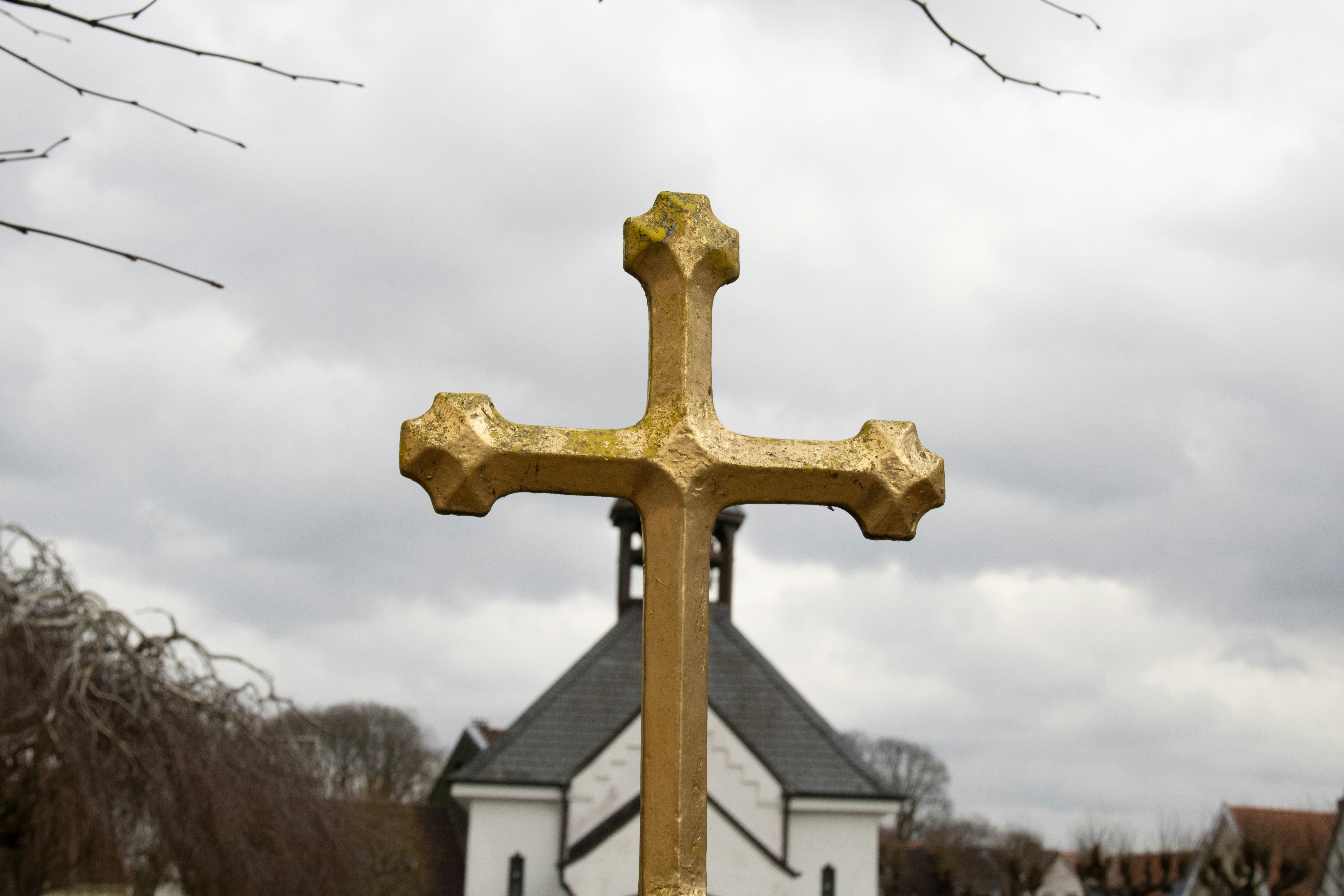 Golden cross in front of a Chapple 