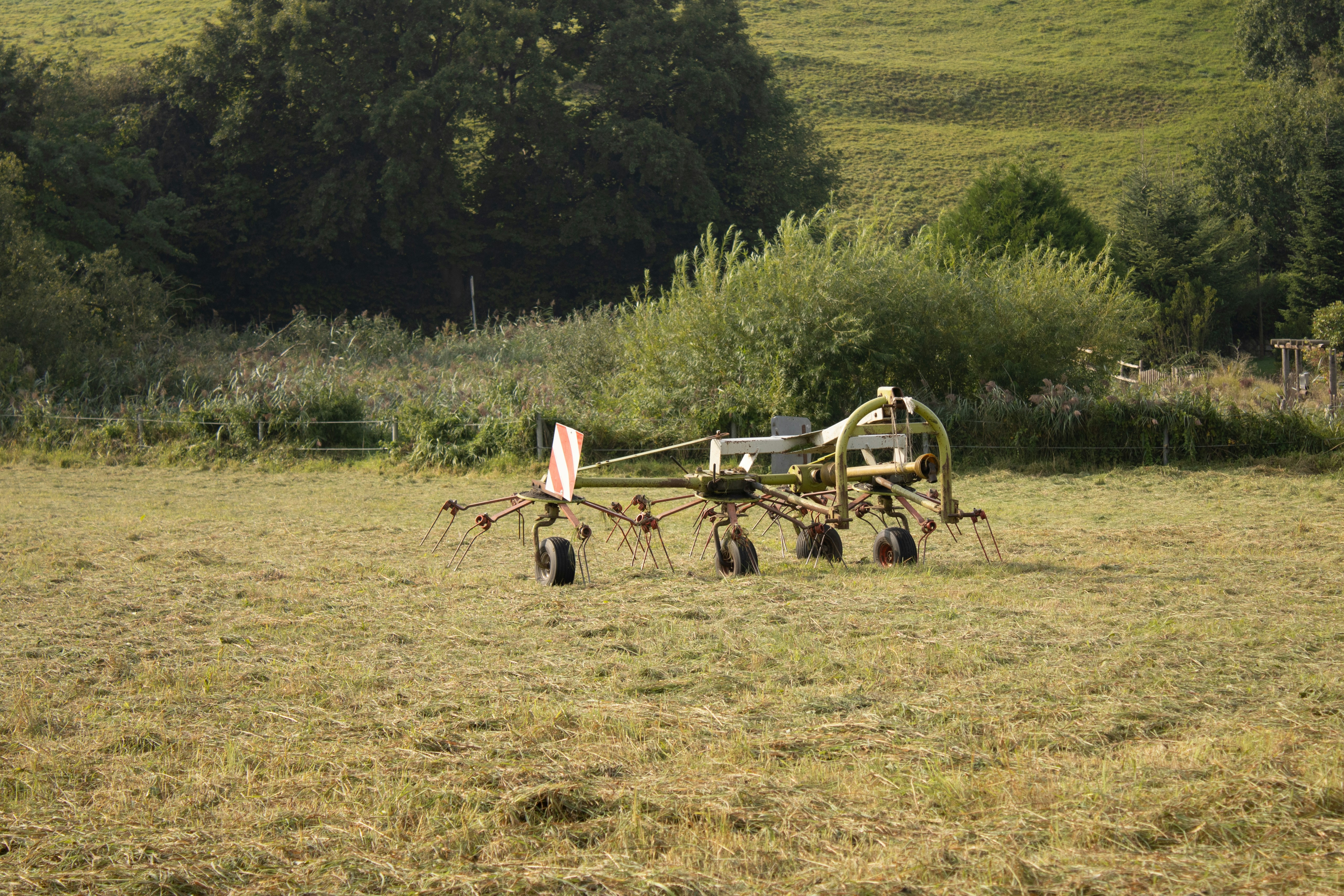 Idle Sprayer Reposed in a Sunlit Harvest Field
