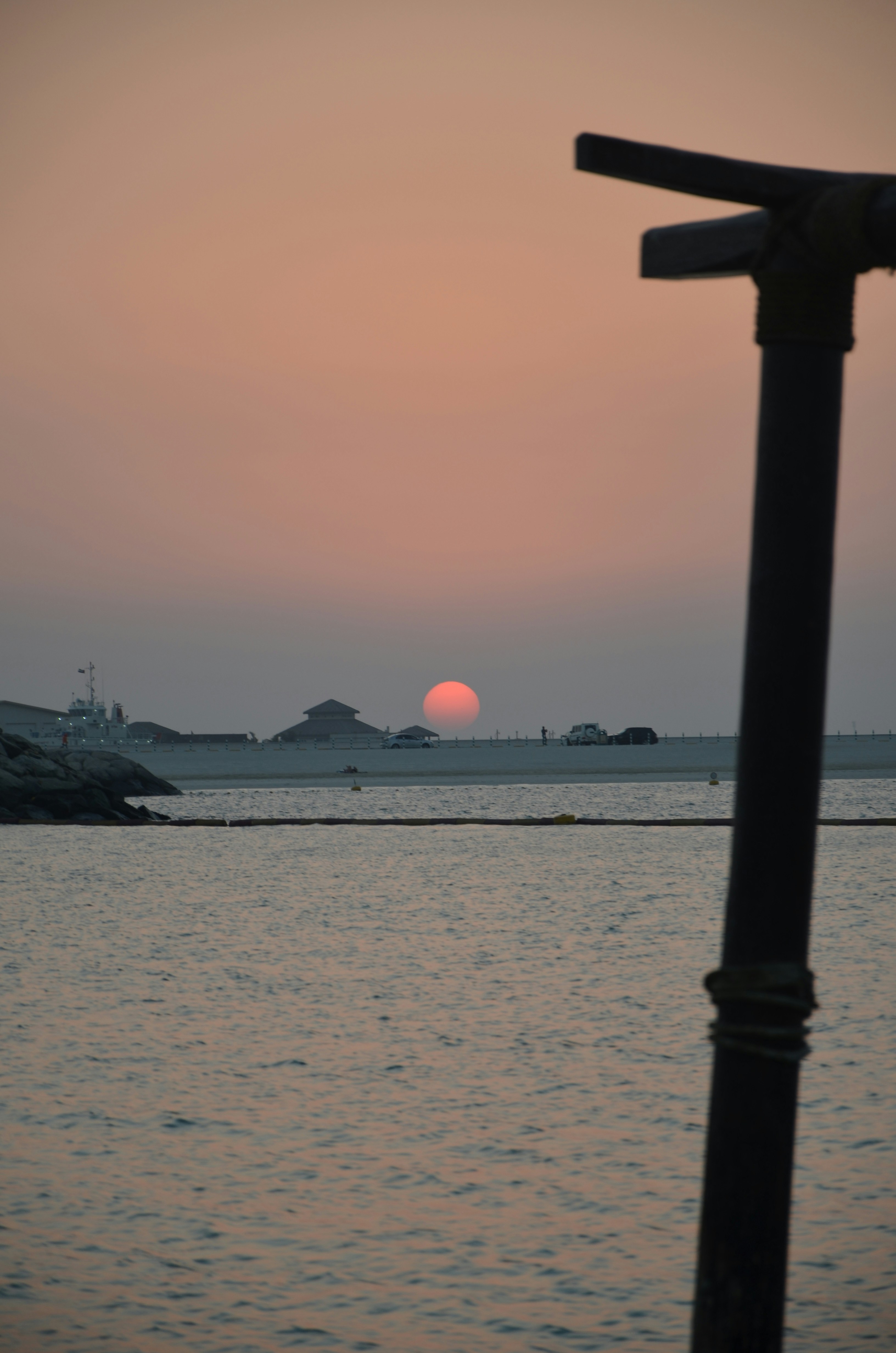 The sun is setting over a body of water photo – Free United arab ...