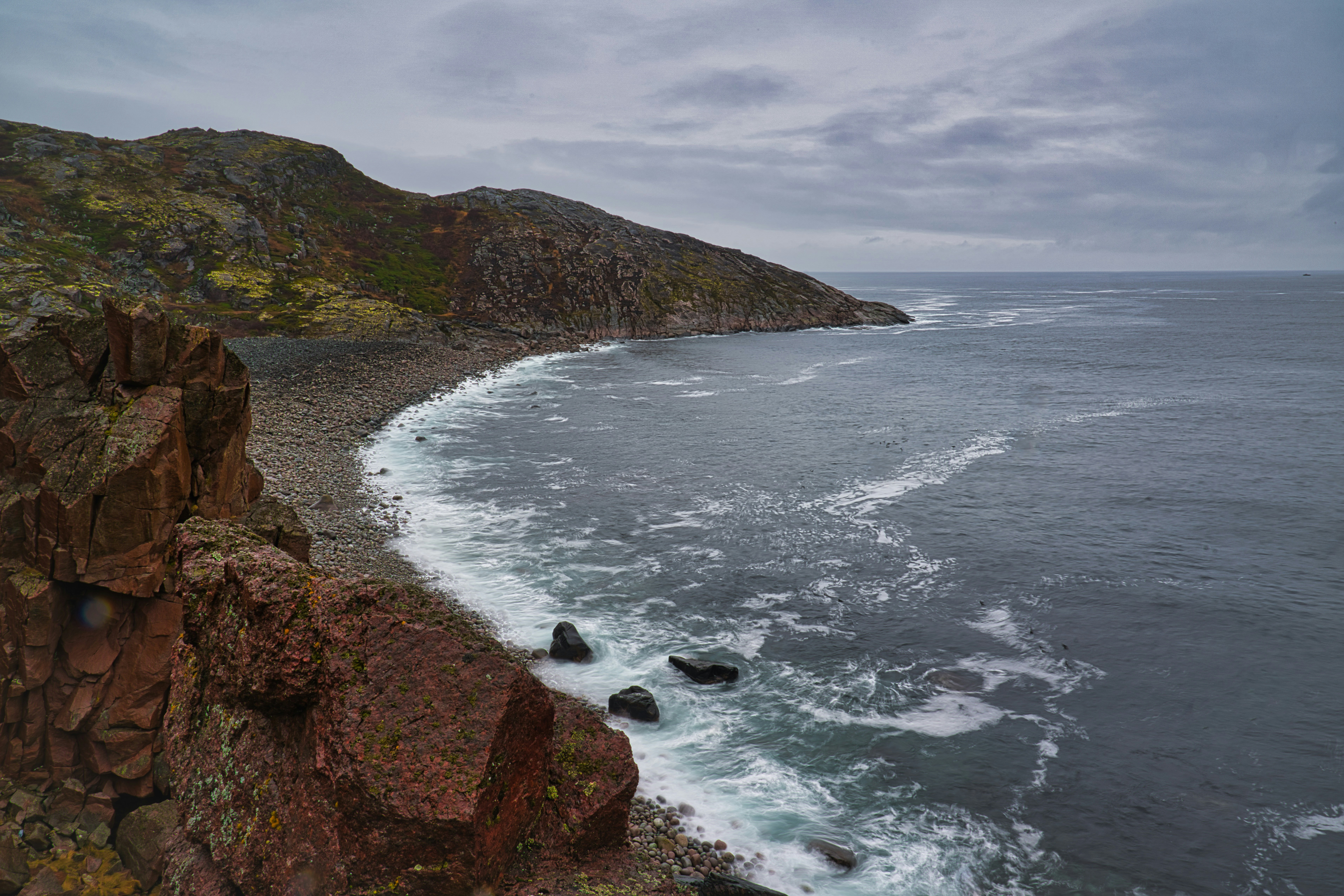Where Red Cliffs Meet the Sea's Quiet Pulse