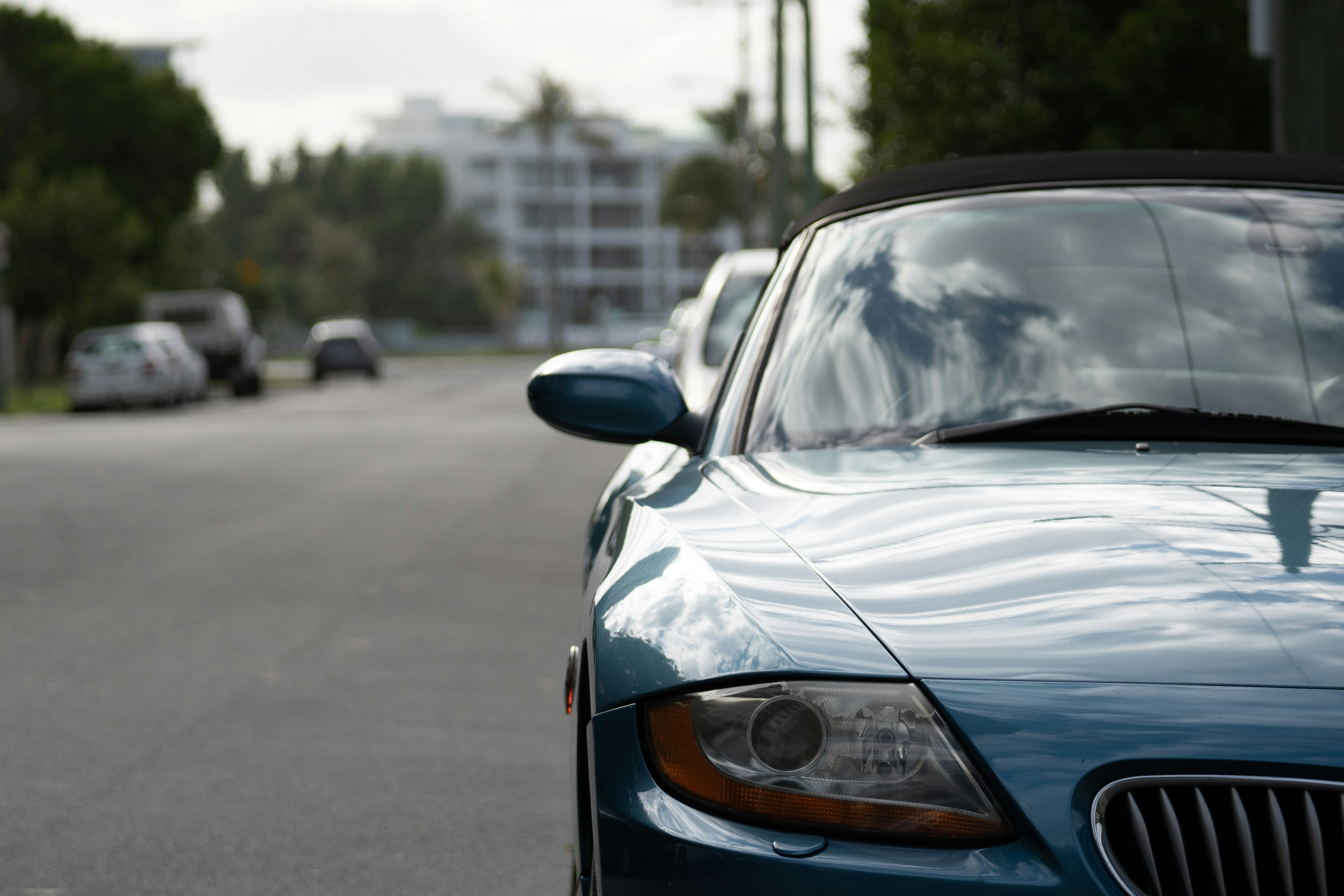 Azure Roadster Reflects the Sky on a Quiet Street