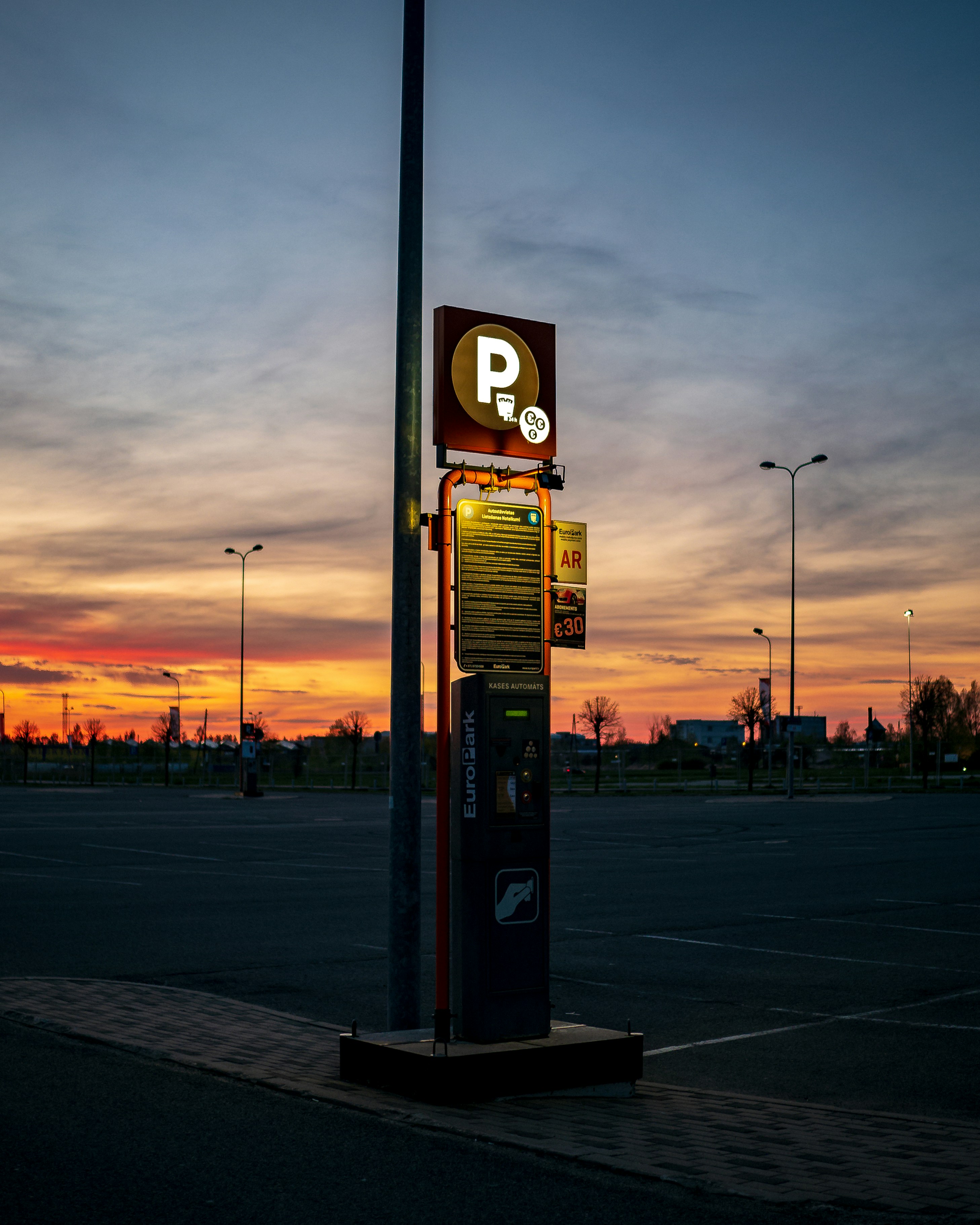 a parking meter sitting on the side of a road