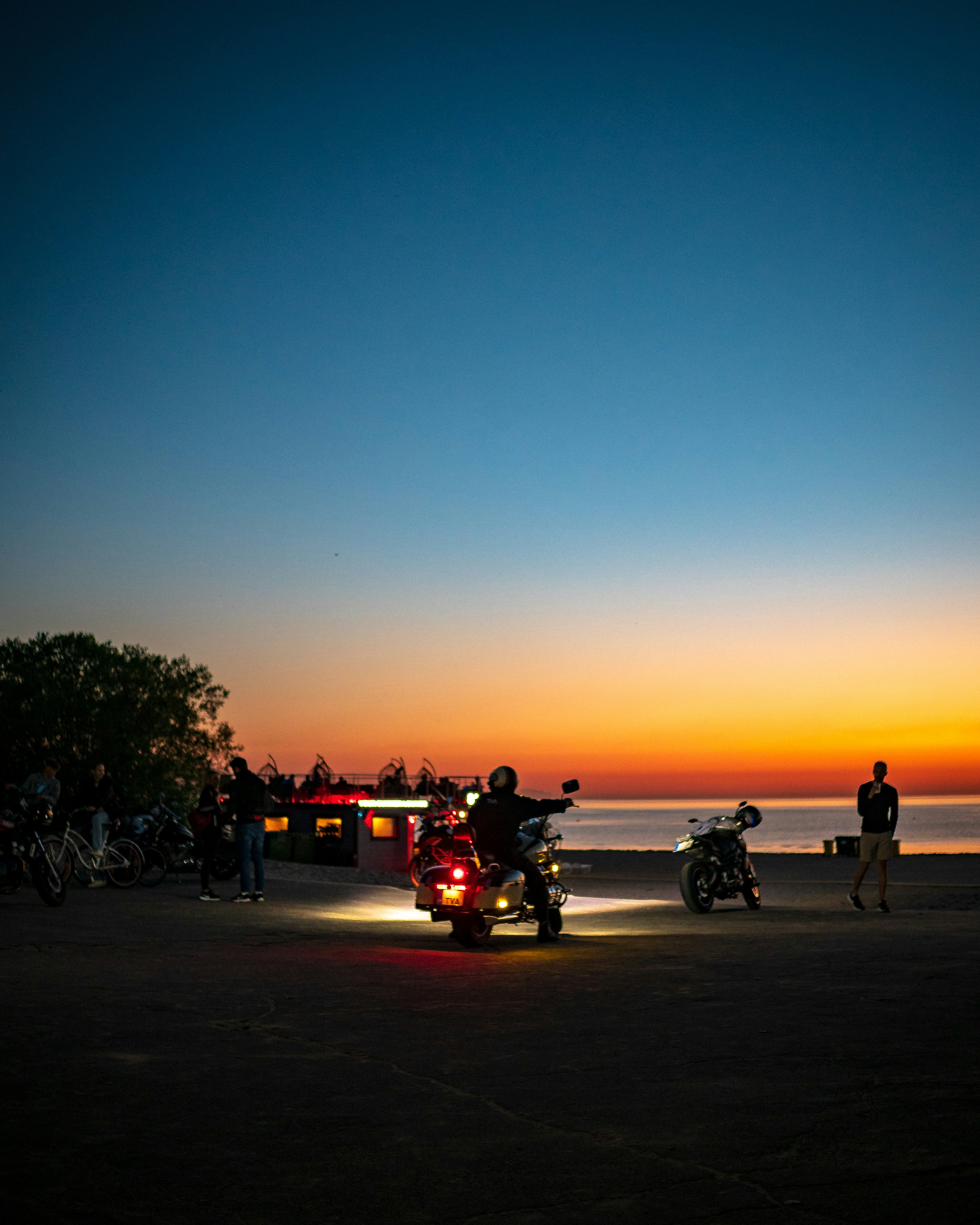 Dusk on the Promenade: Headlights, Silhouettes, and the Quiet Sea