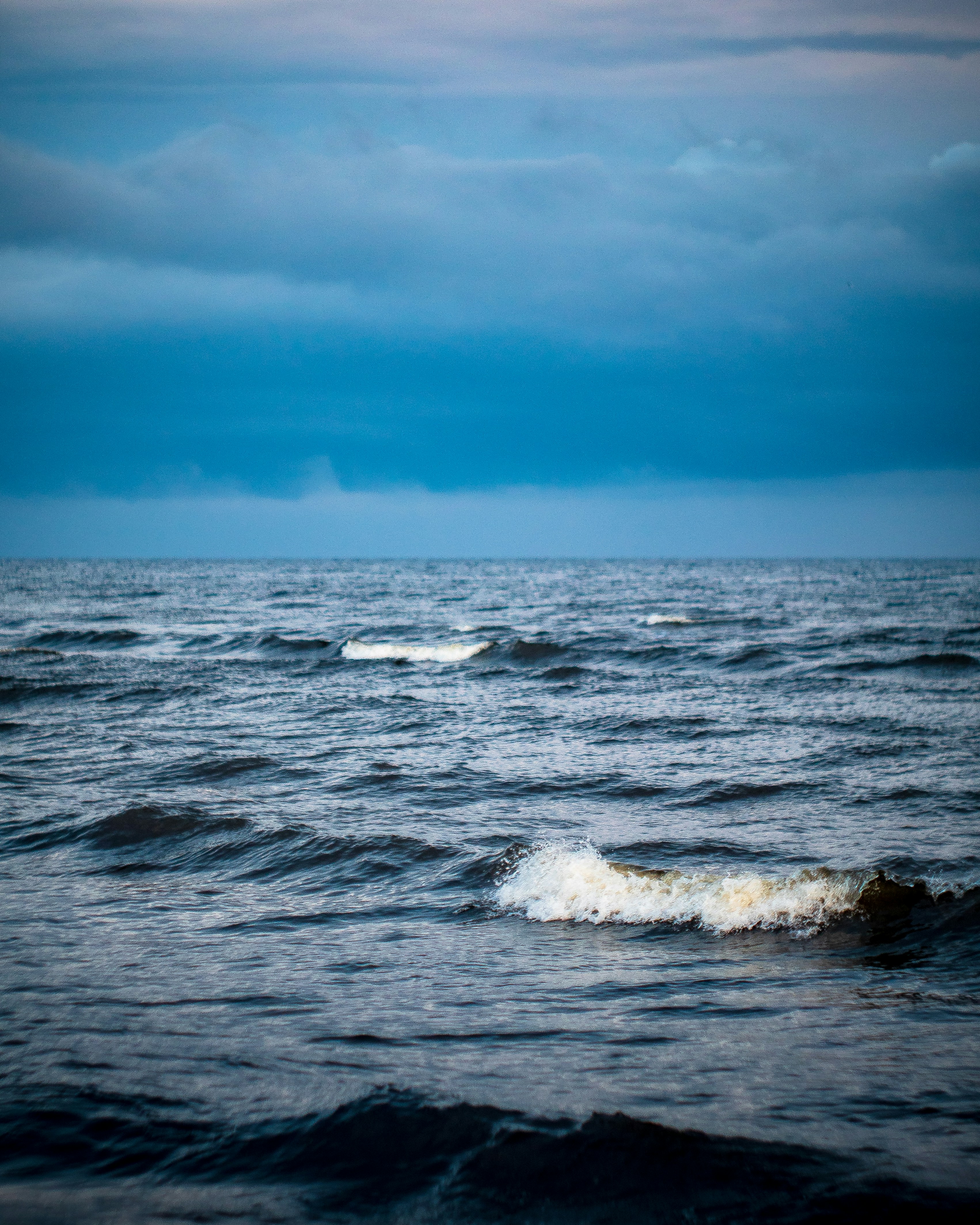 Cobalt Crest: Waves Meet a Layered Indigo Sky