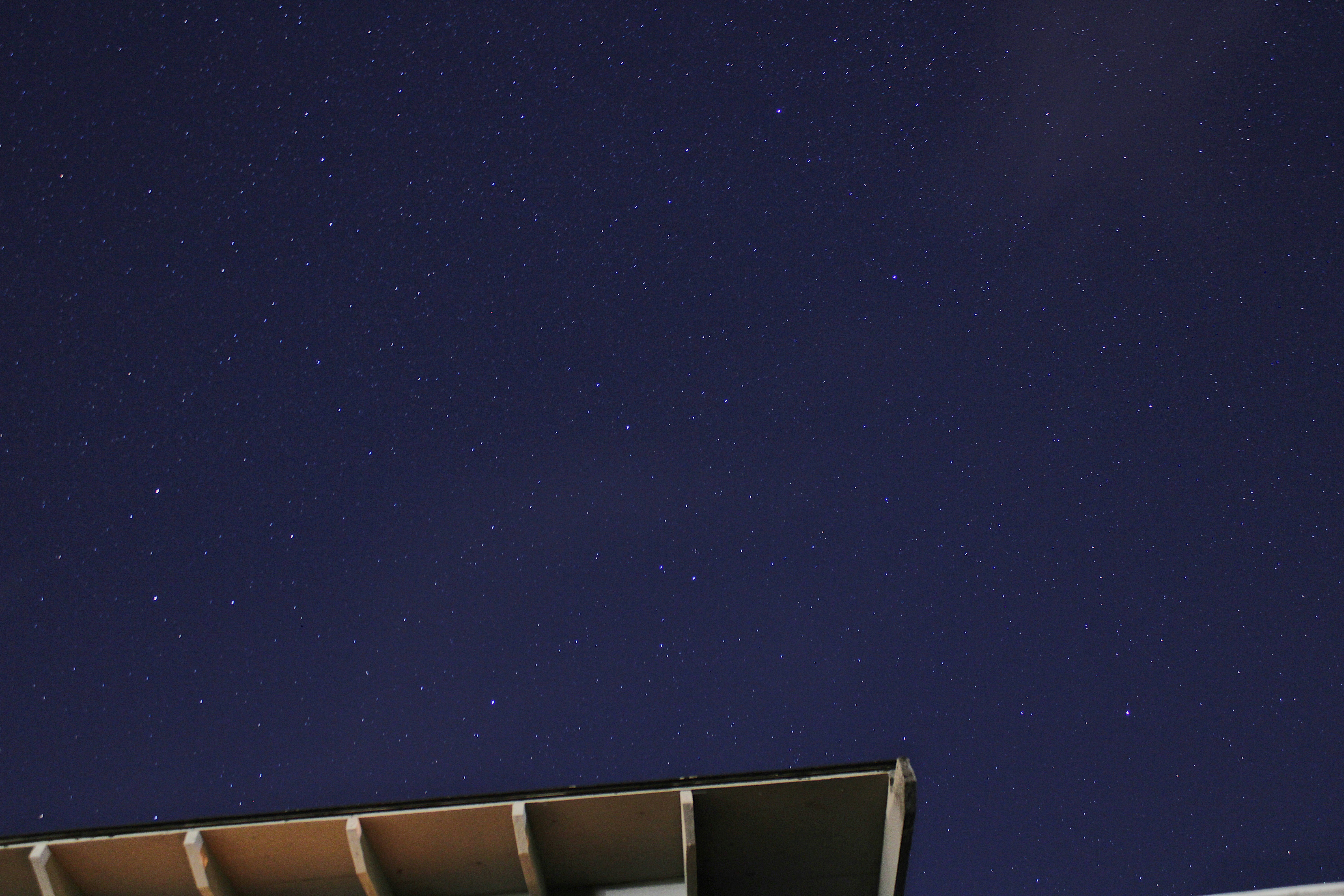 The night sky with stars above a building photo – Free Night Image on ...