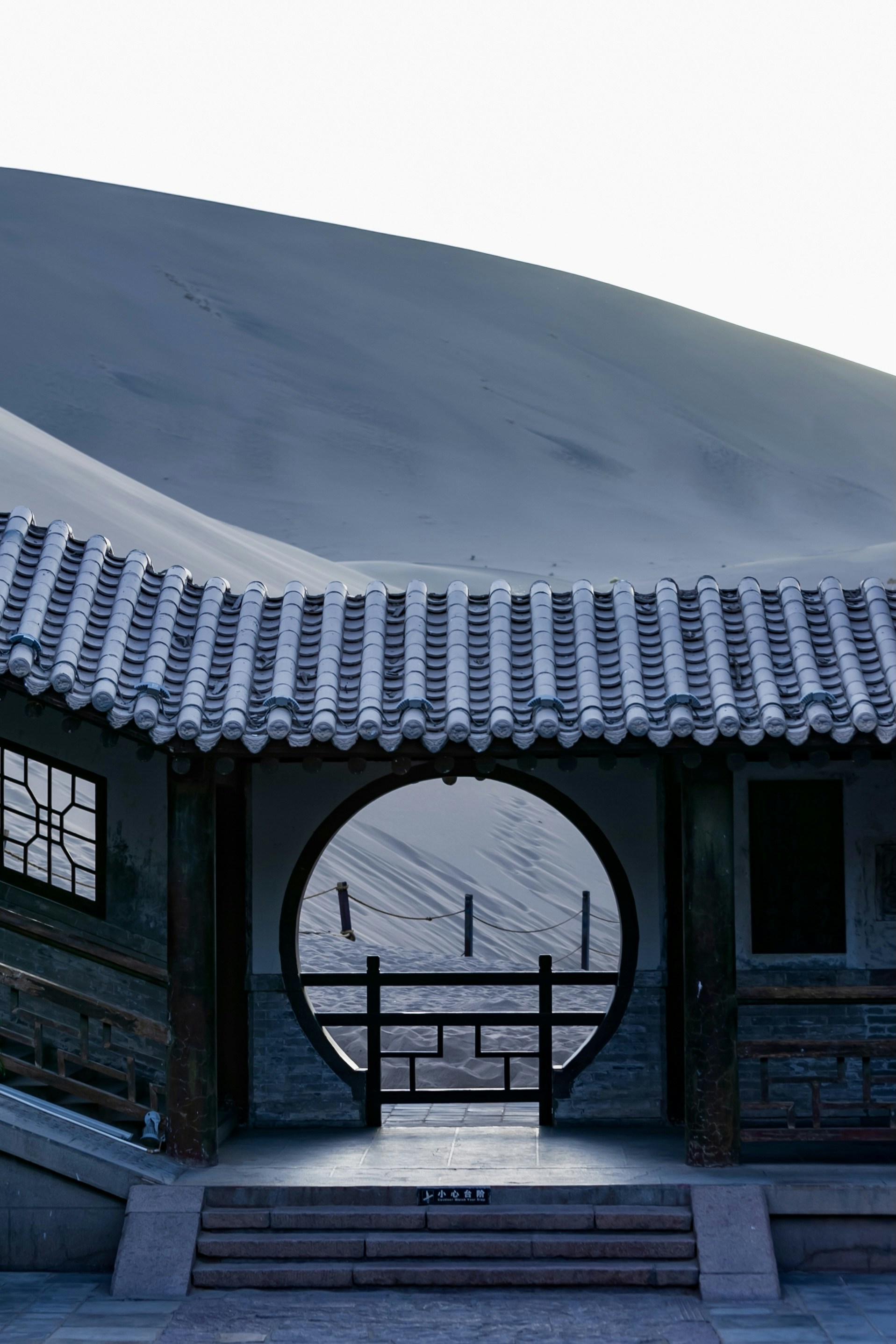 Moon Gate Vista: Snow-Dusted Ridge Framed Through a Circular Portal