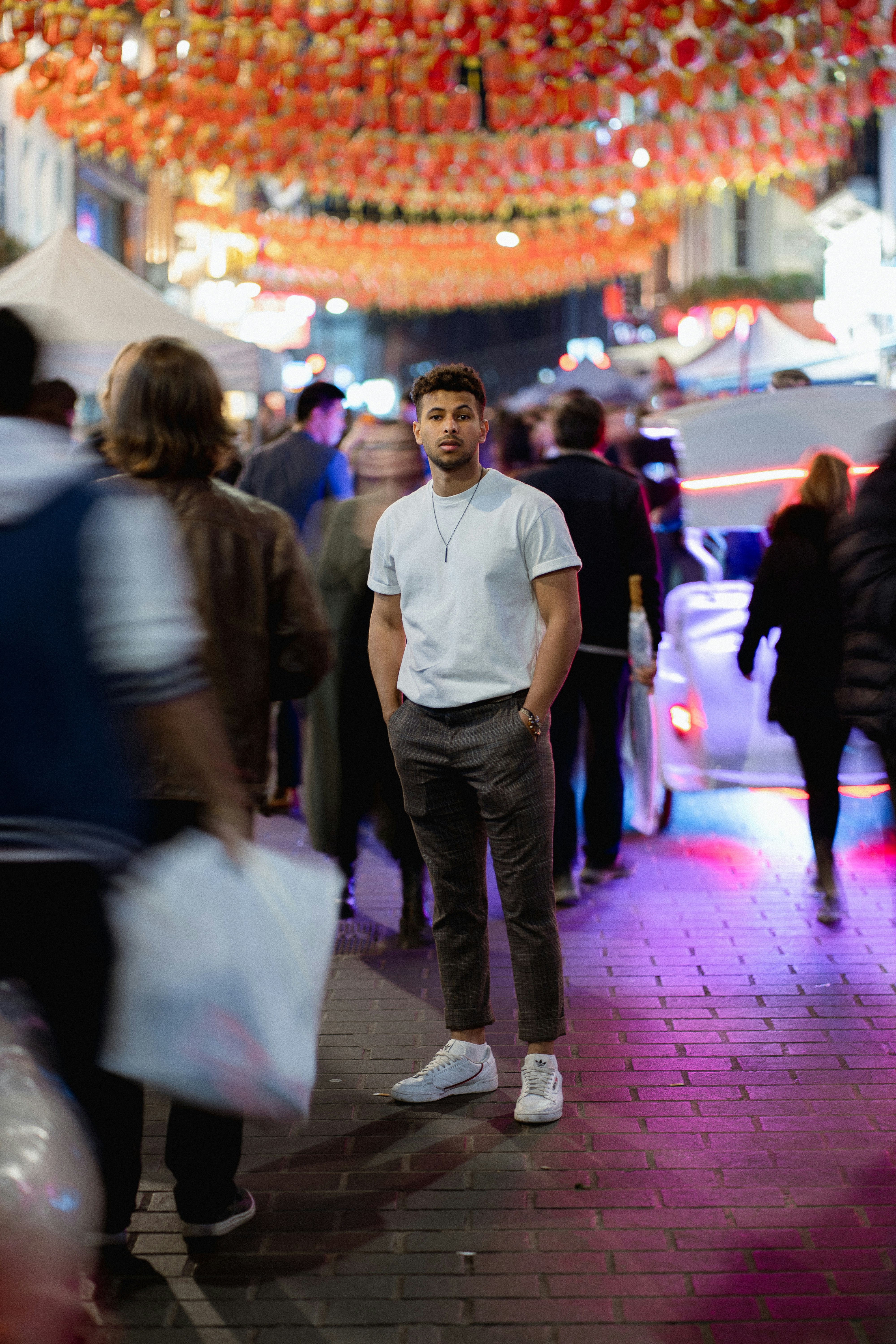 Center Stage Under Lanterns: A Quiet Street Portrait in Neon Night