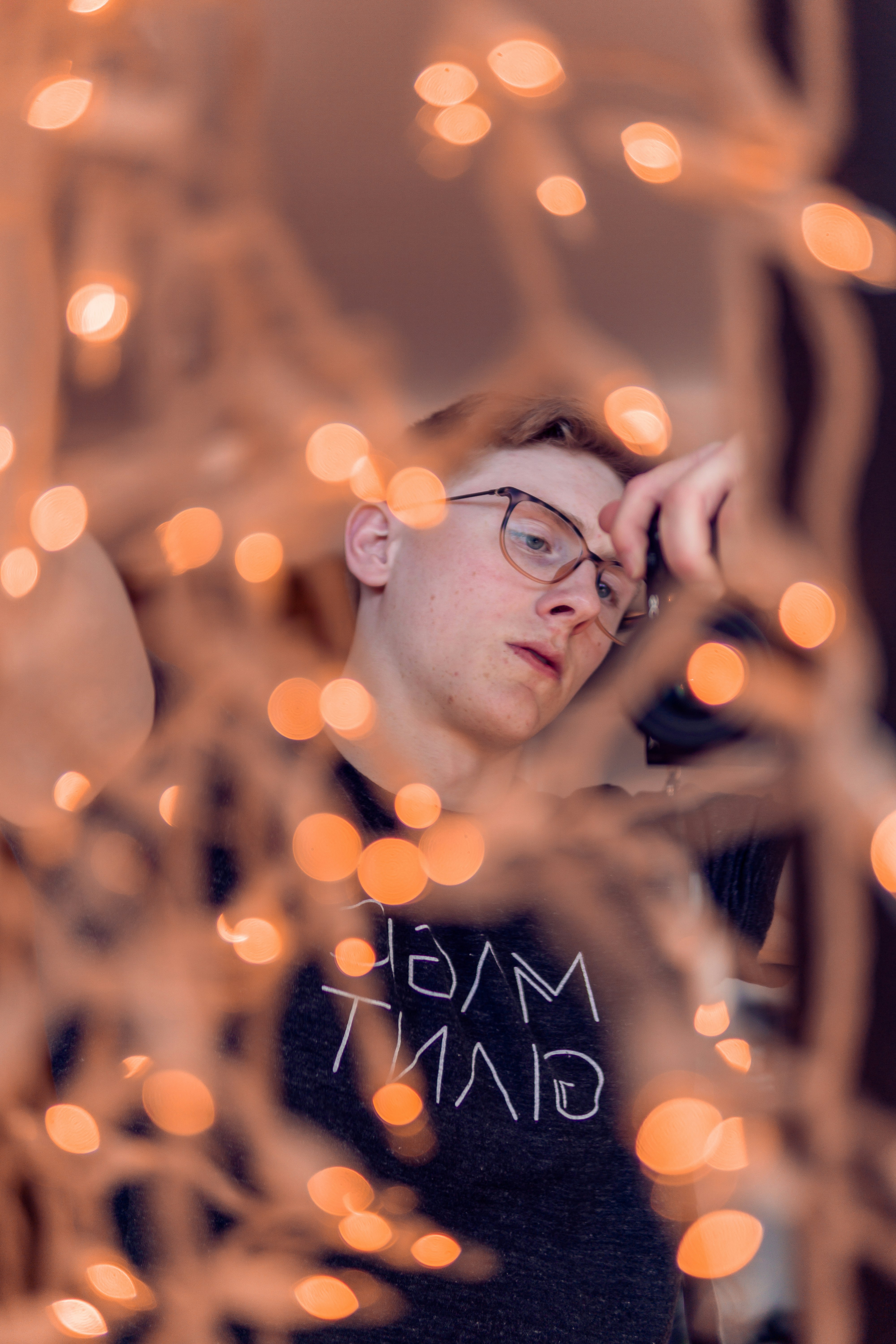 Glow-Frame Gaze: A Portrait Amid Warm Bokeh Orbs