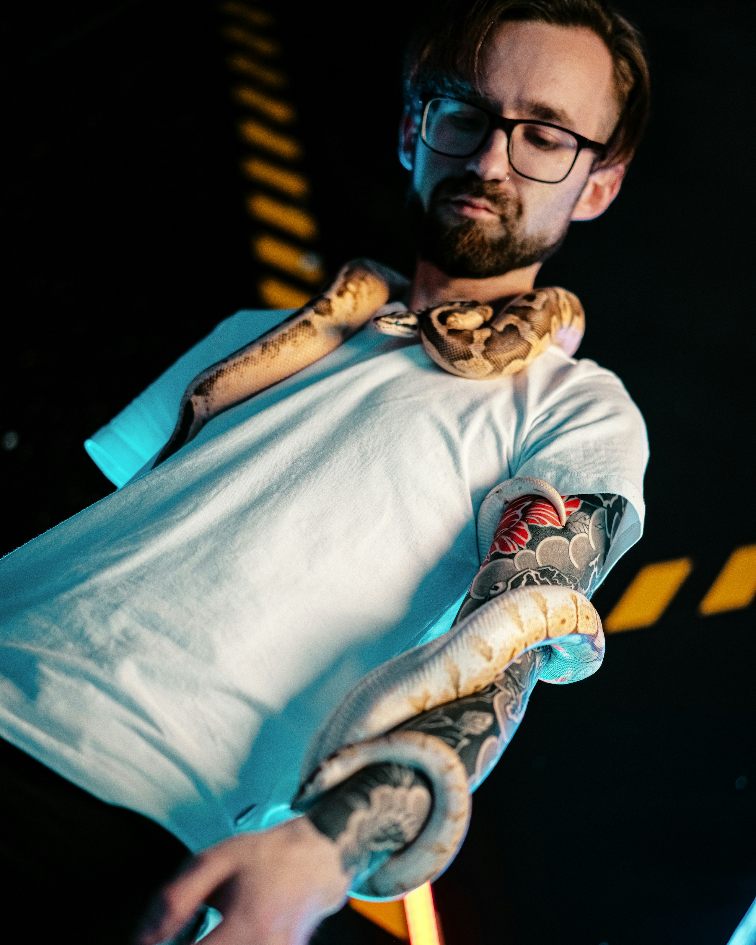 a man with a snake on his arm