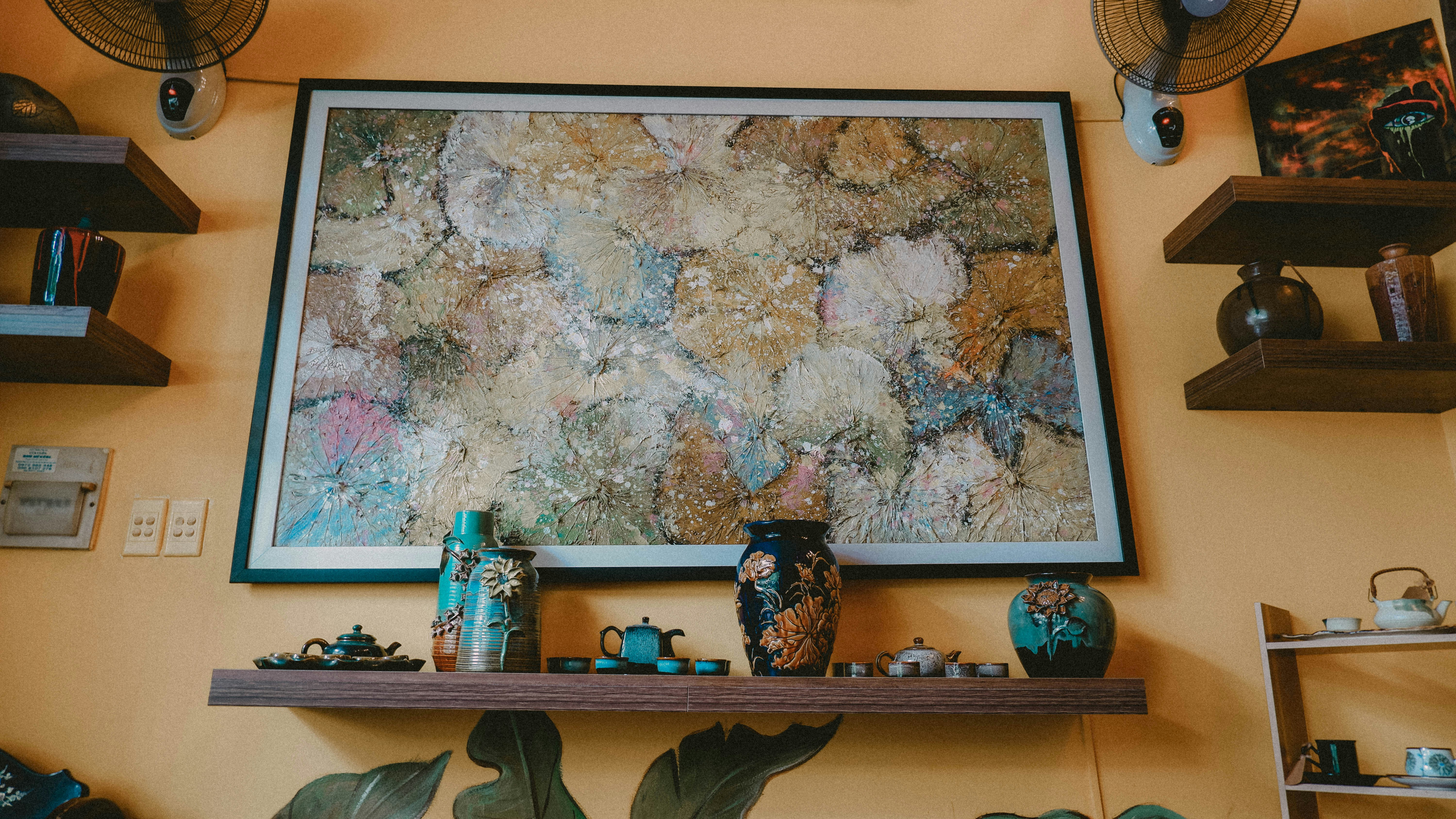 A painting on a wall above a shelf photo – Free Art Image on Unsplash