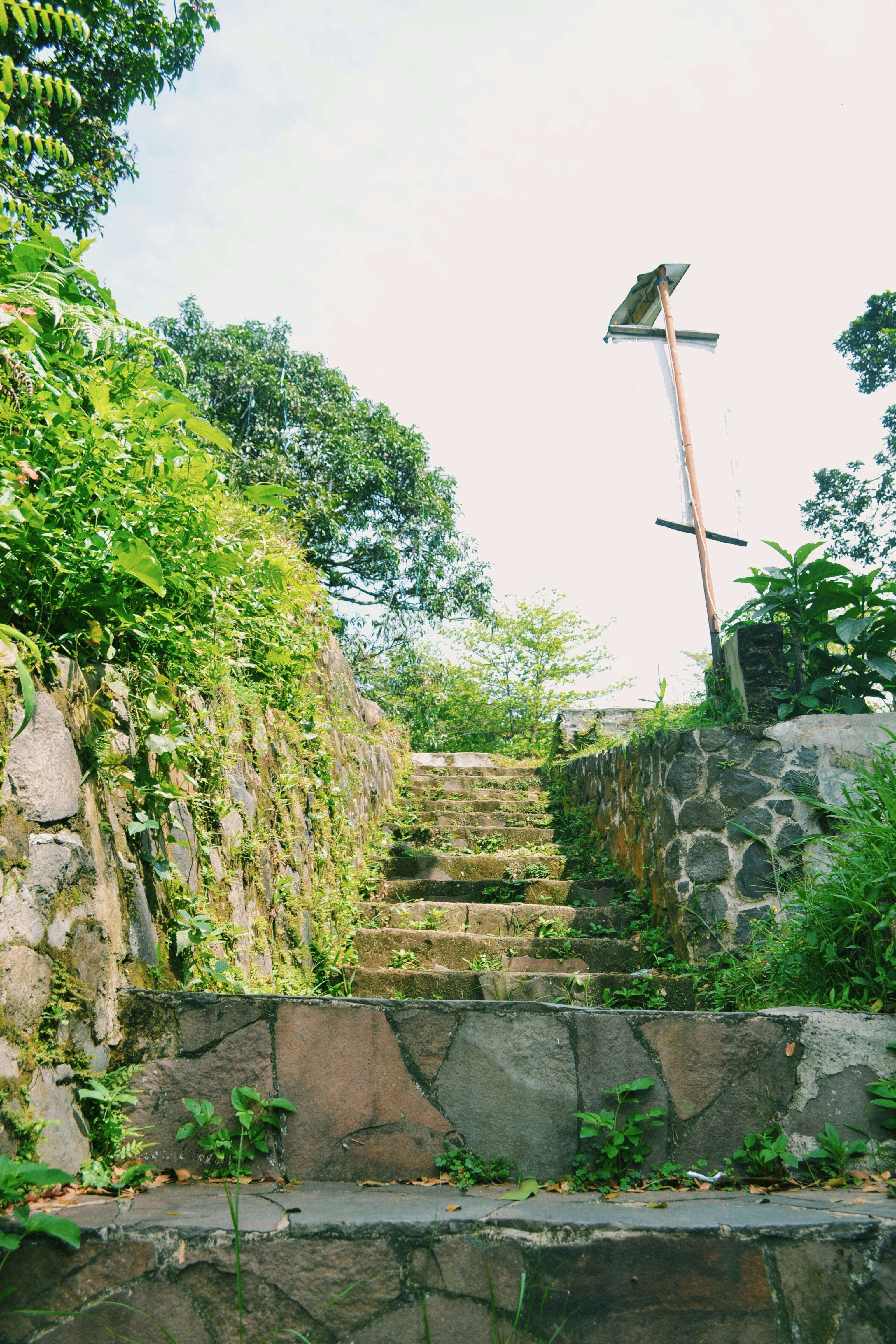 a set of stone steps leading up to a light pole