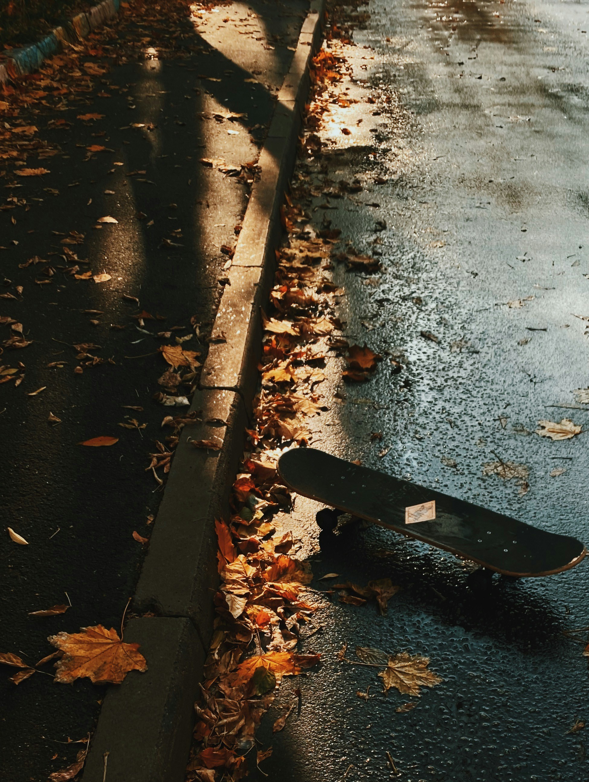 a skateboard laying on the side of the road