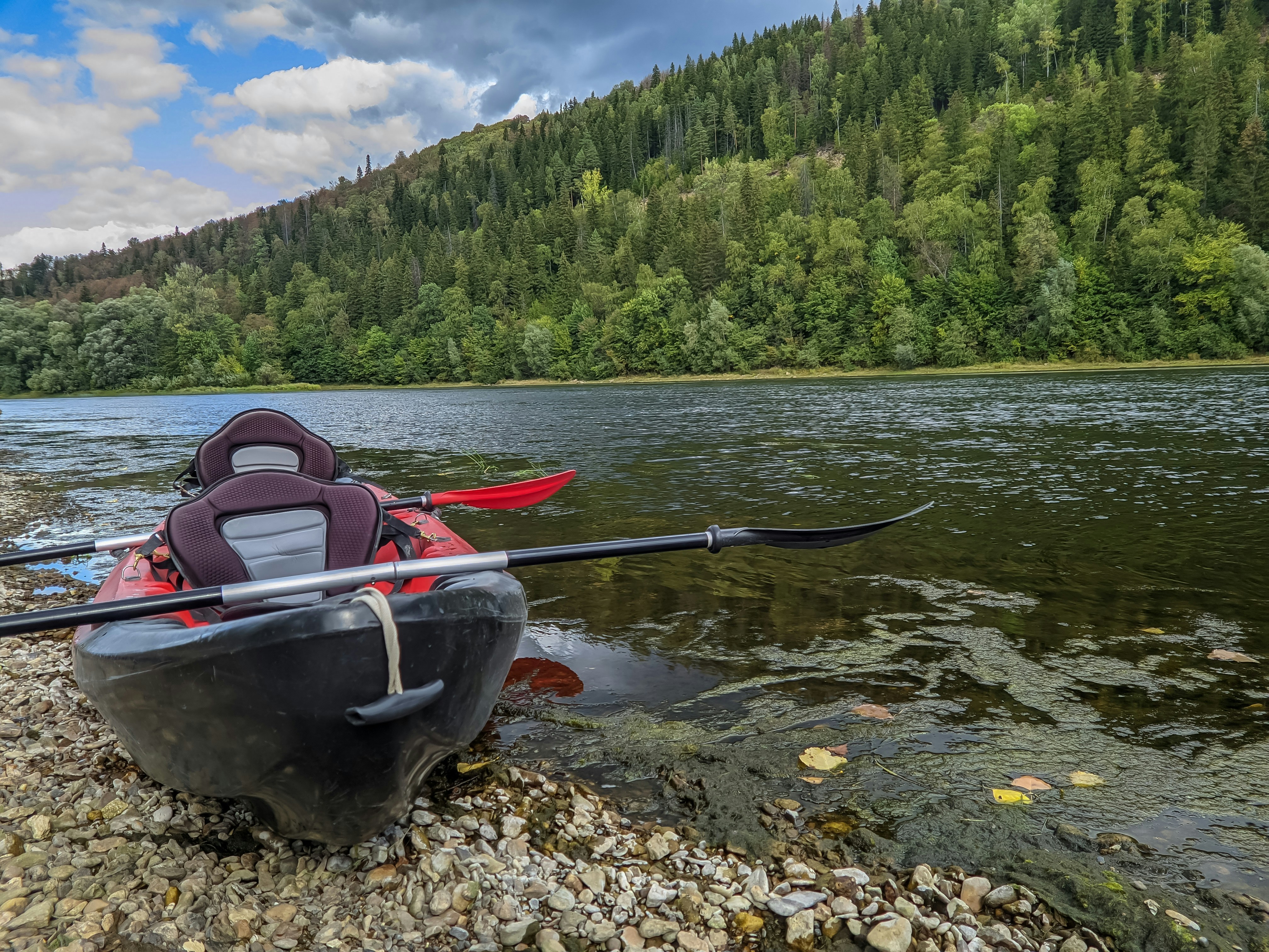 A kayak sitting on the shore of a lake photo – Free Nature images Image ...