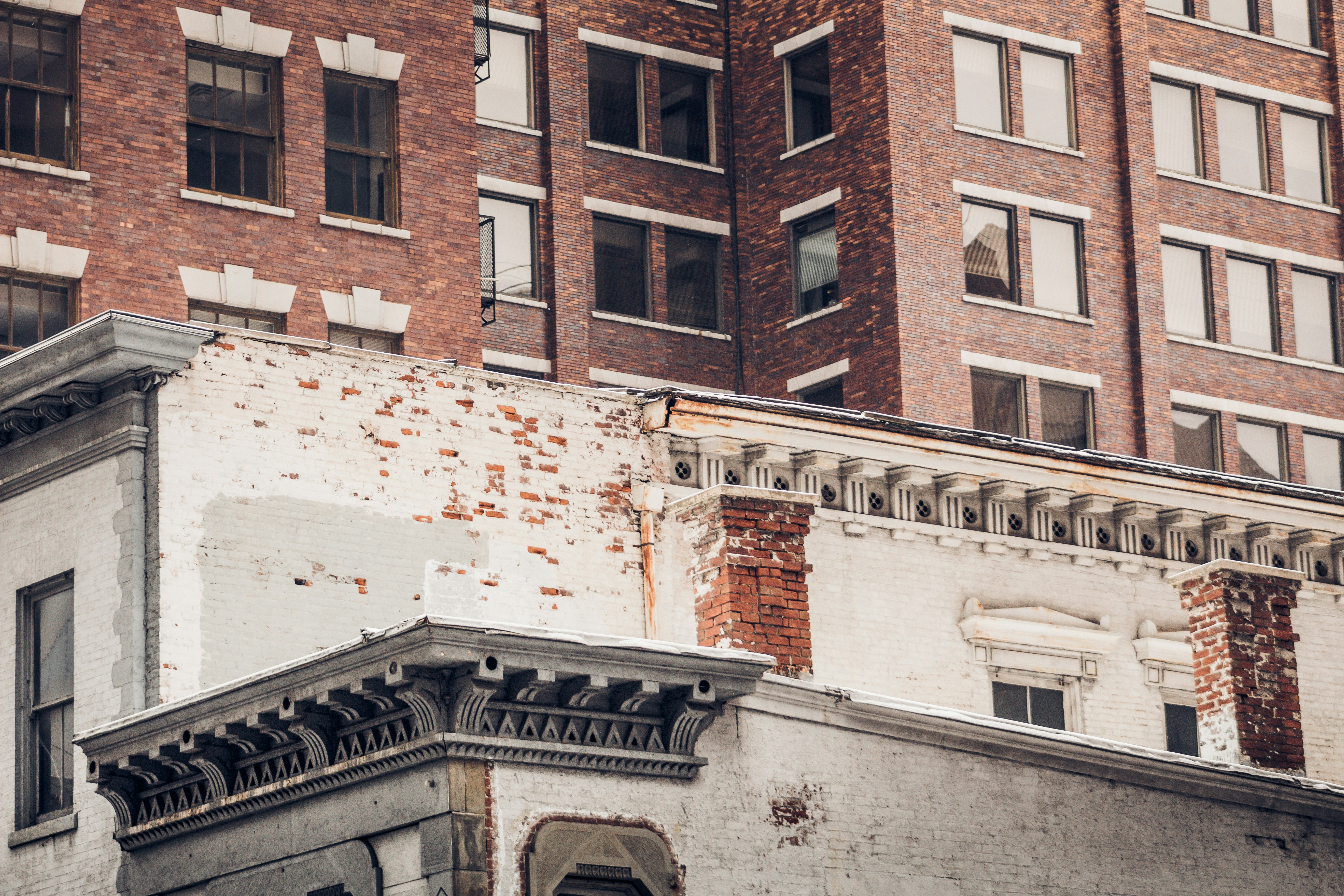 Edge of Time: The Weathered Facade Where Brick Meets Cracked Plaster