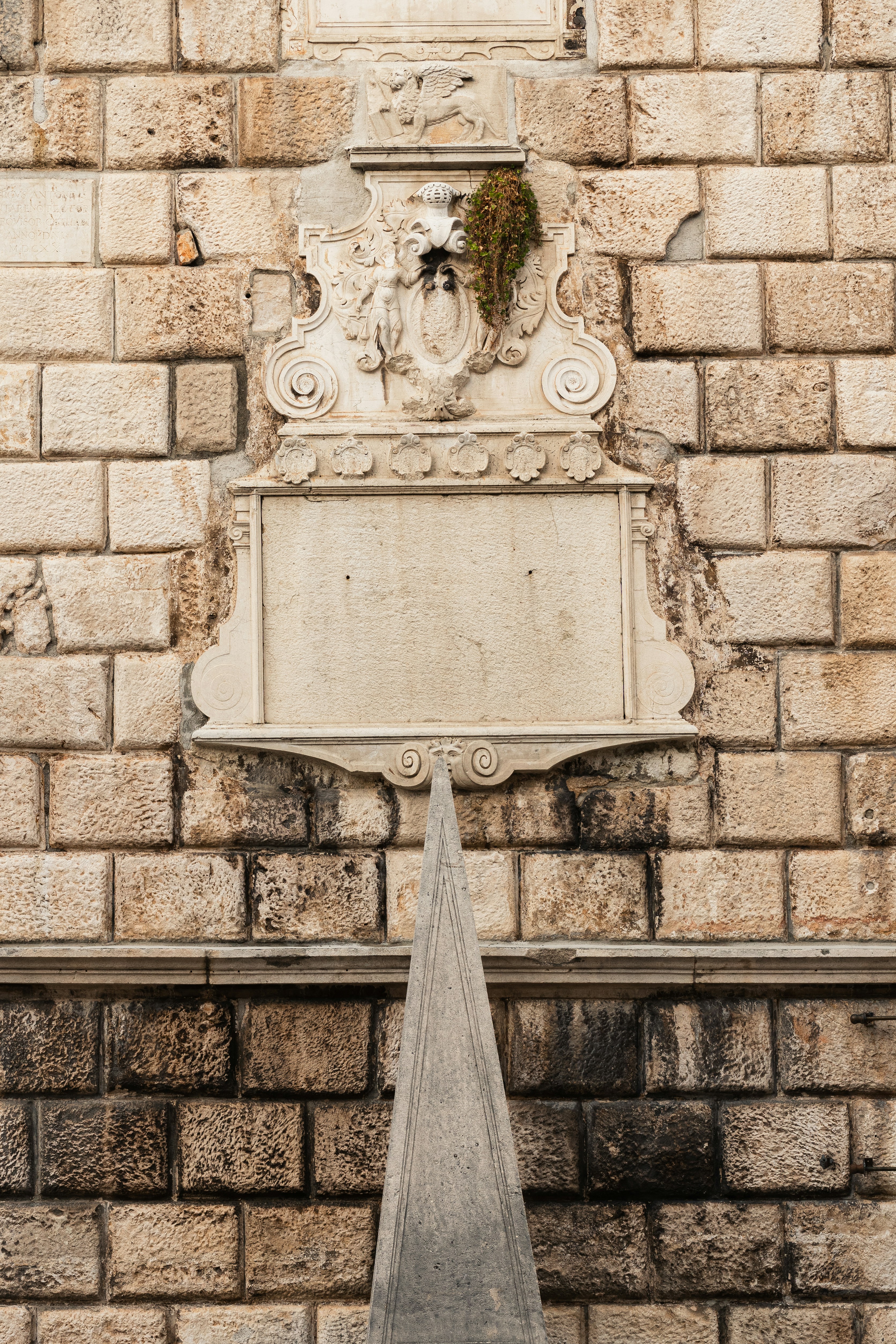 Stone Fountain Emblem Adrift on a Weathered Wall