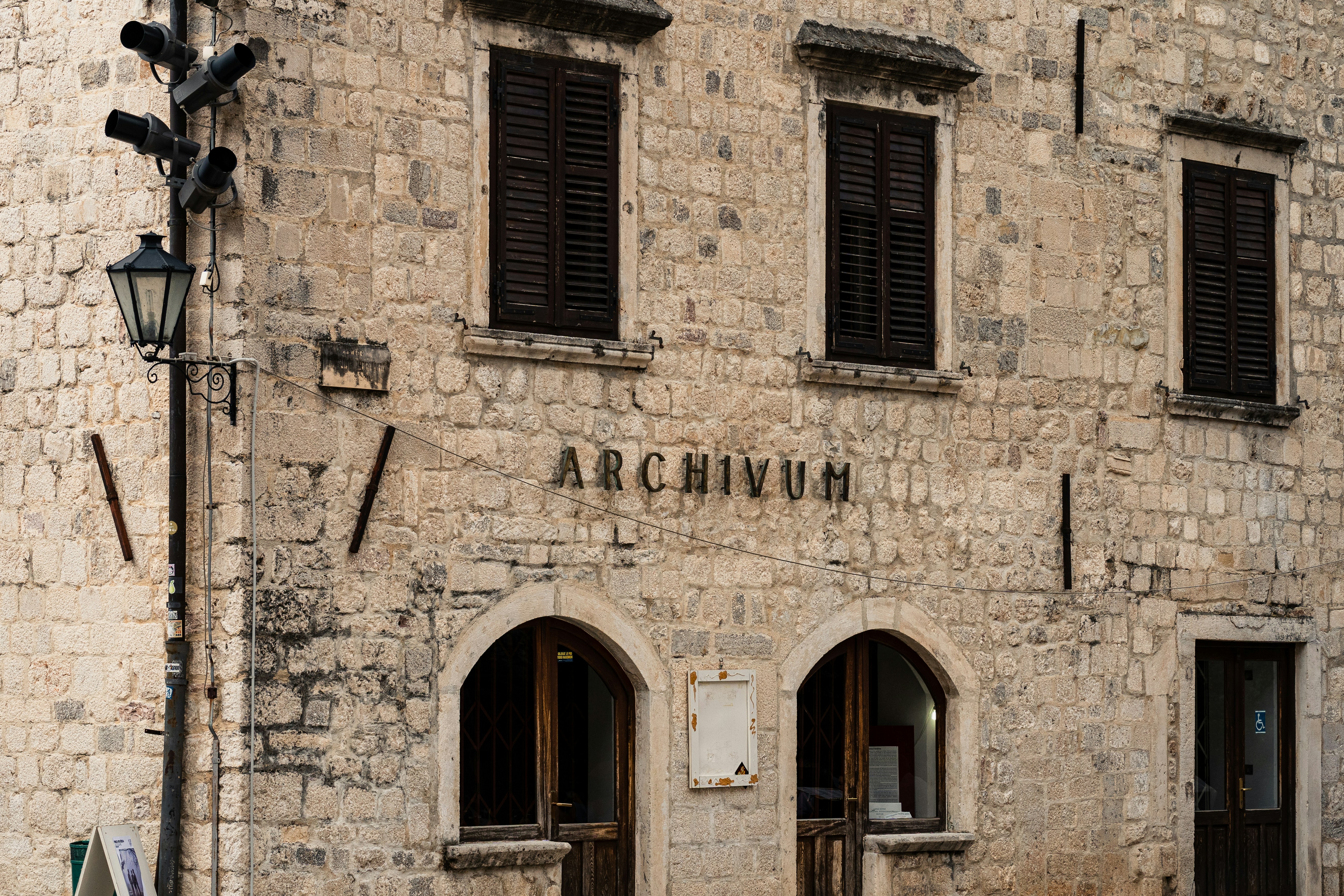 Archivium Facade: Quiet Arches in Weathered Stone