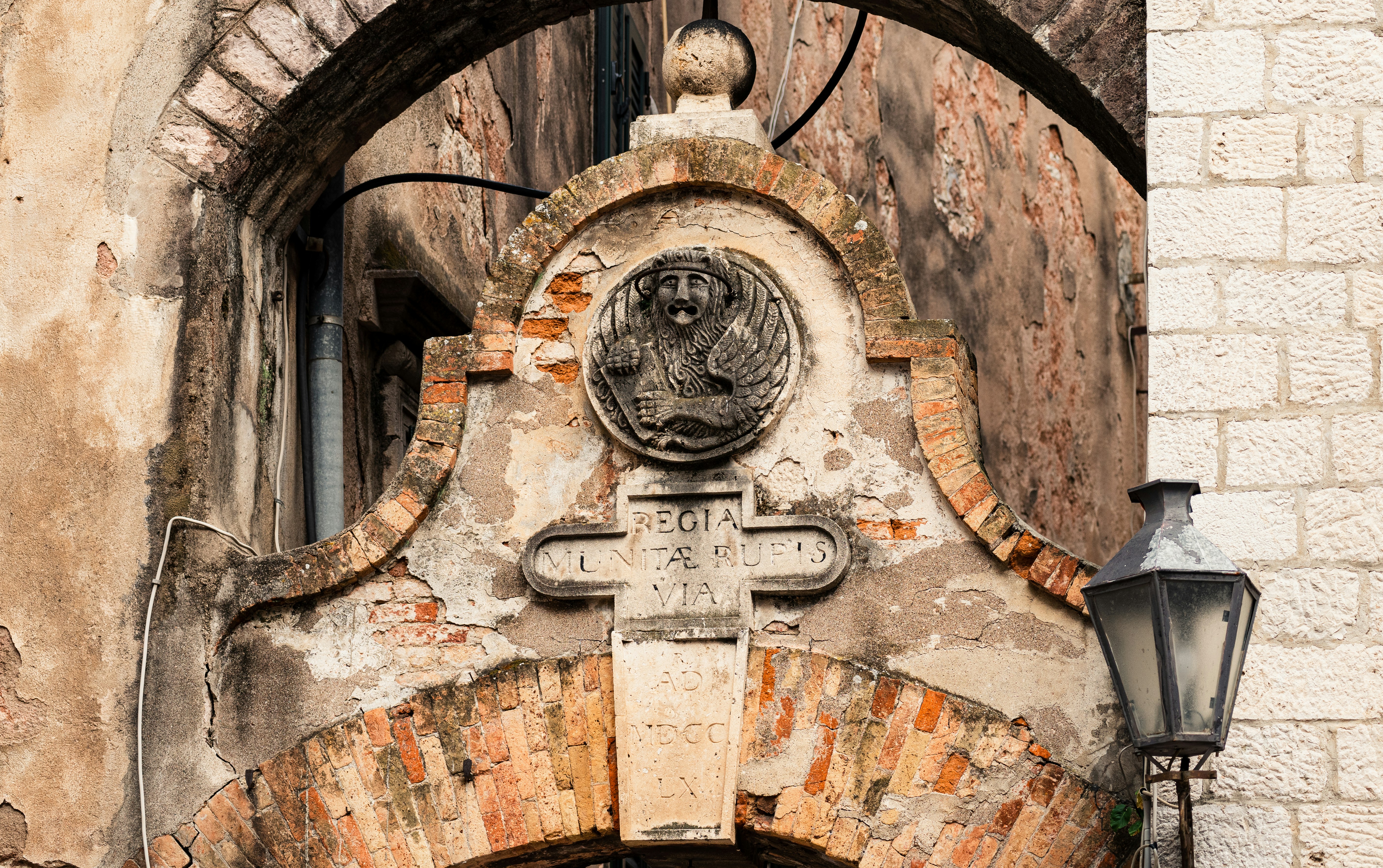 an old building with a door and a sign on it