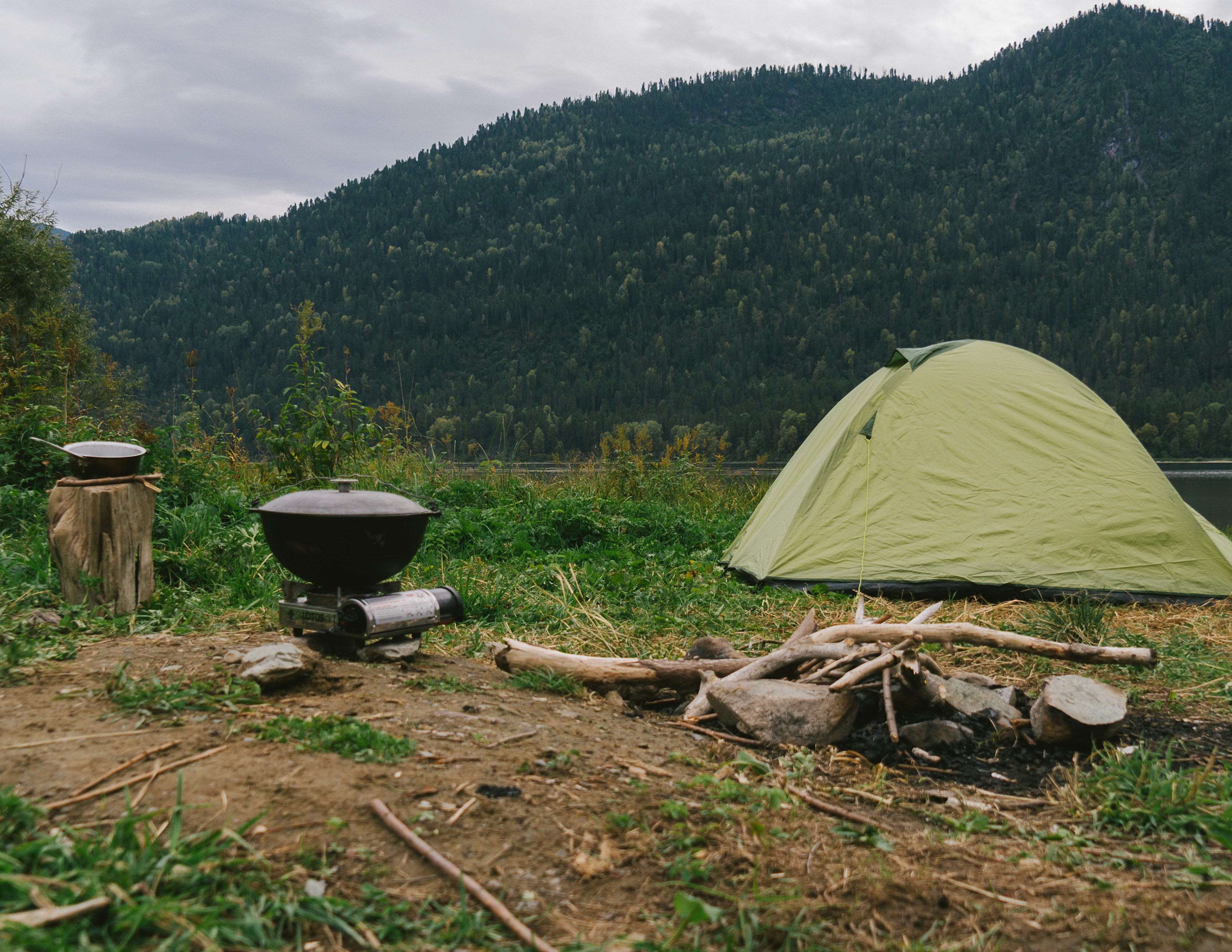 Lime Tent at the Campsite: Firelight and Forested Peaks