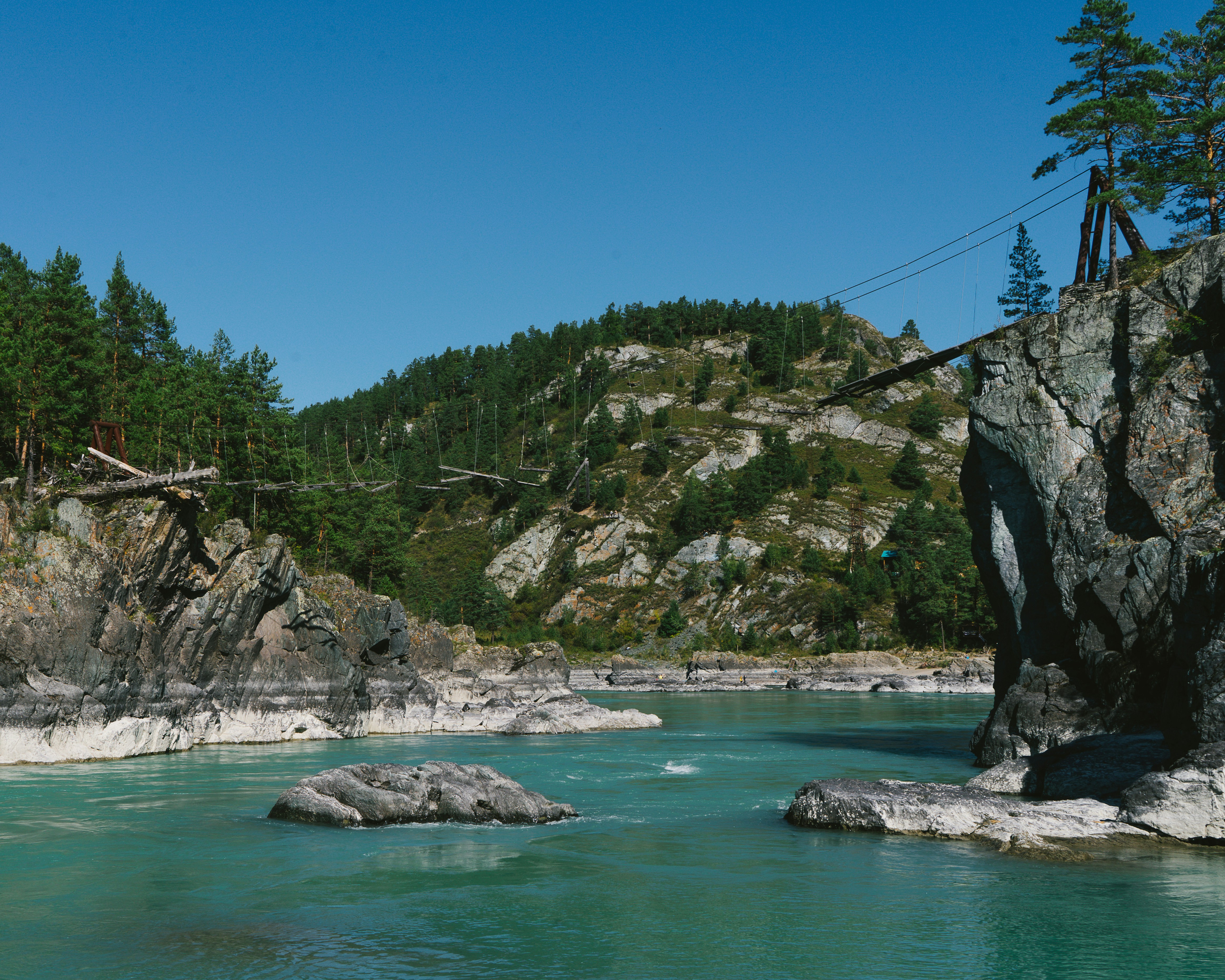 Suspended Bridge over a Turquoise Gorge