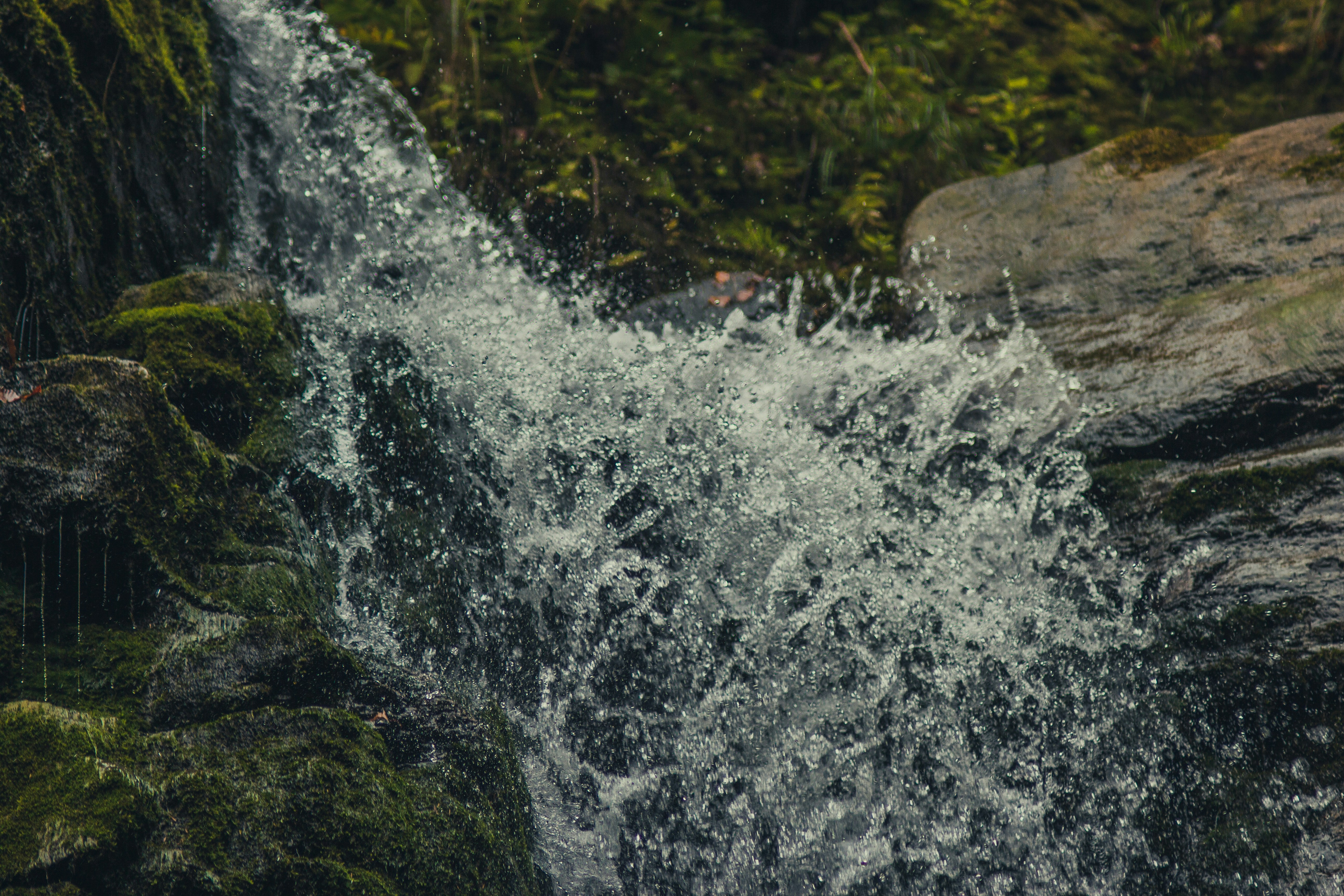 A waterfall with water splashing over rocks photo – Free Grey Image on ...