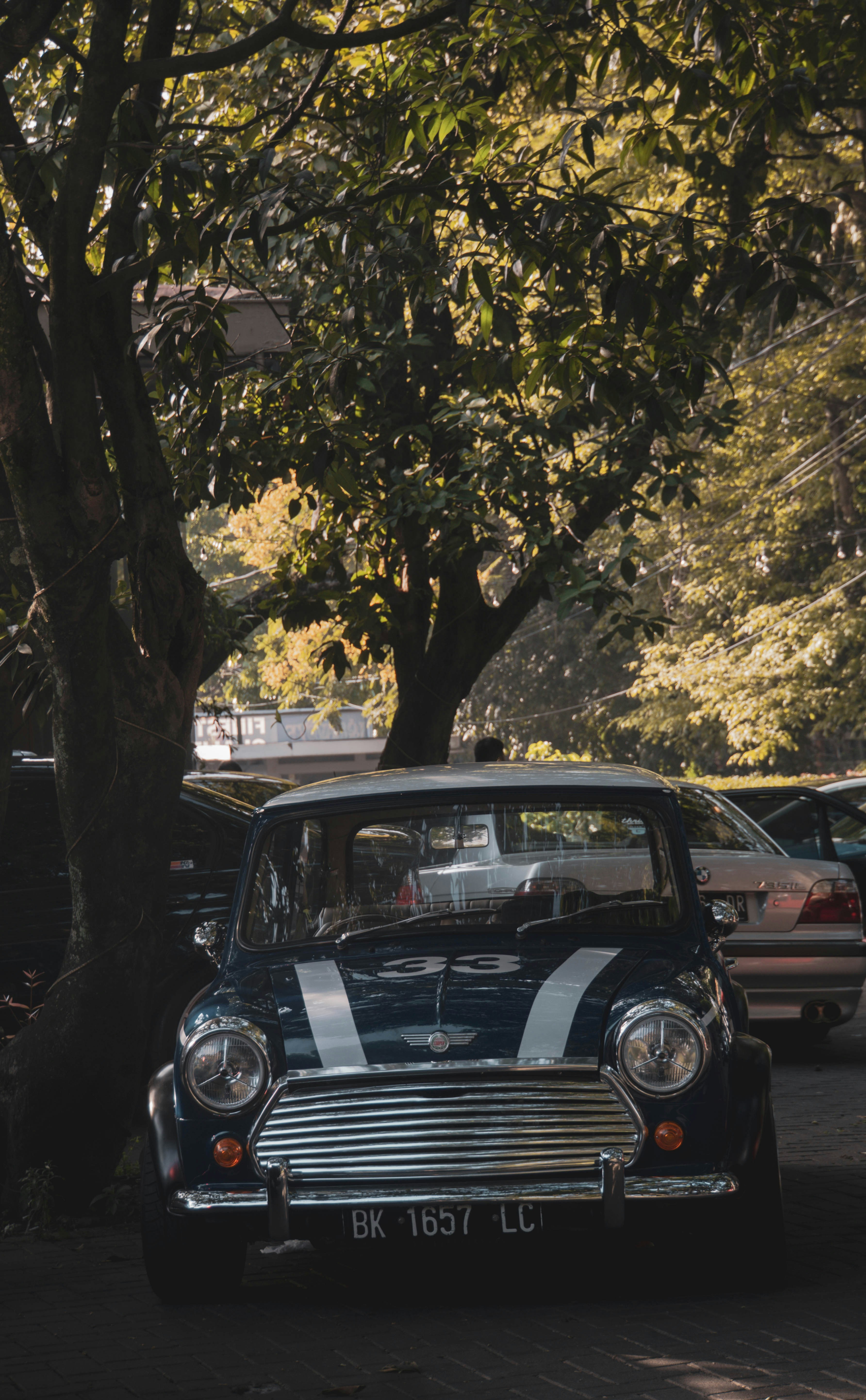 an old car is parked on the side of the road