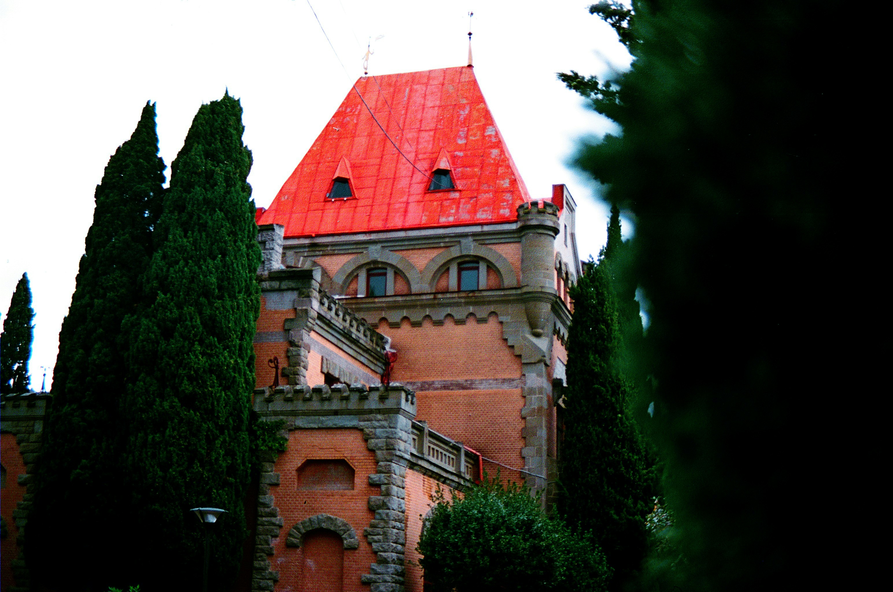 A tall red brick building with a red roof photo – Free Green Image on ...