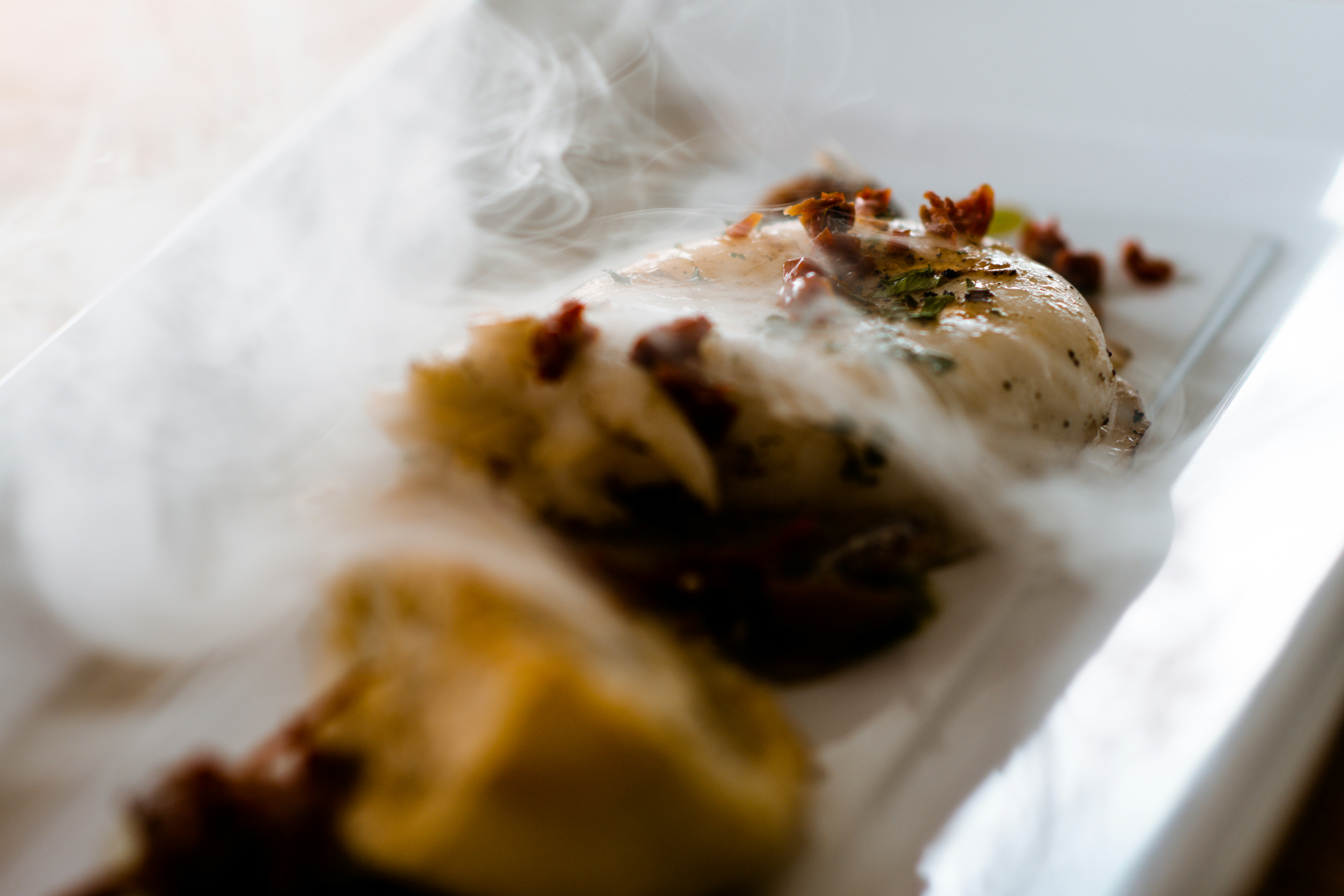 Volcano of Flavor: A Close-Up of a Creamy Gourmet Dish Unfolding on a Narrow Plate
