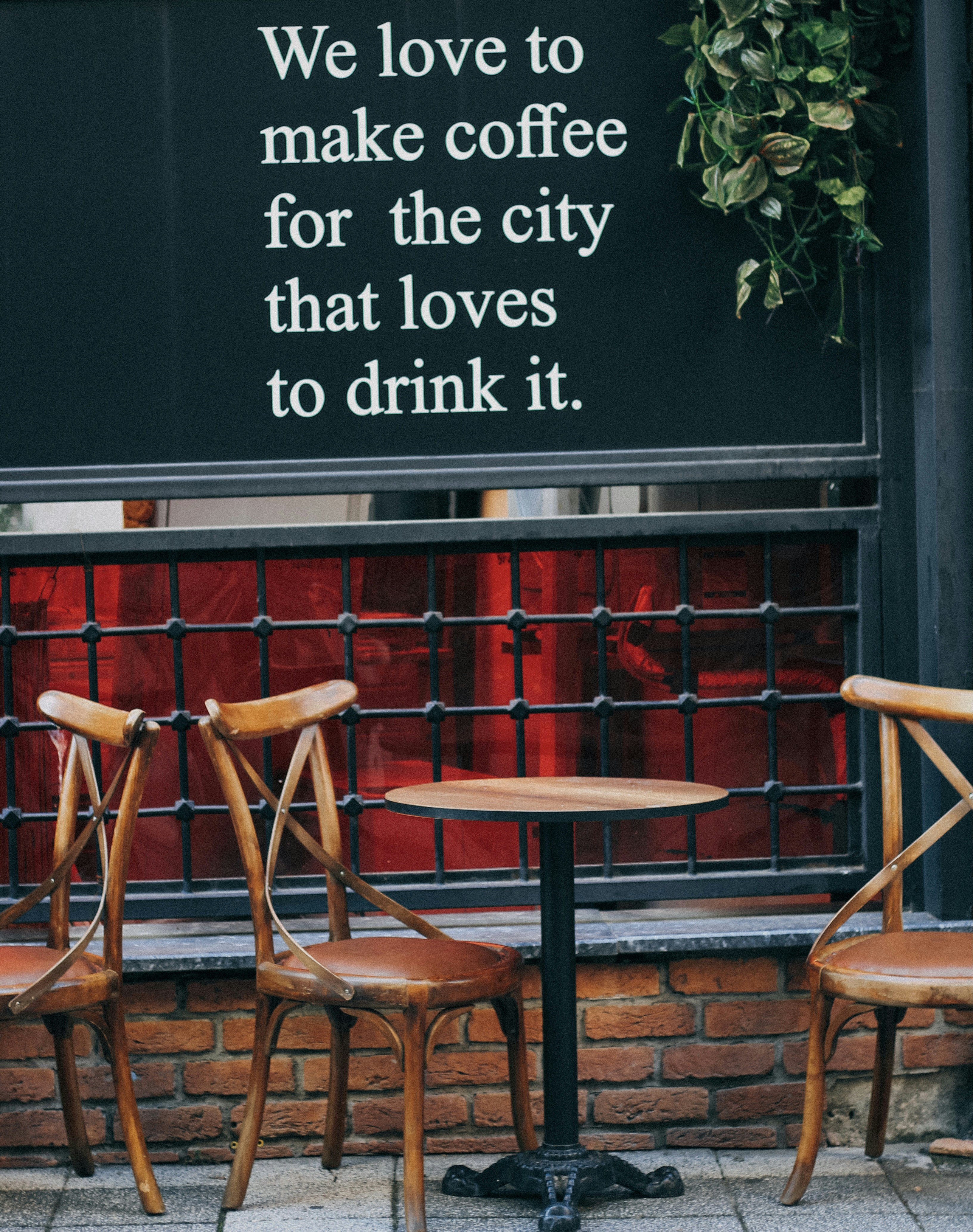 Circular Table Under a Coffee Sign: An Urban Café Moment
