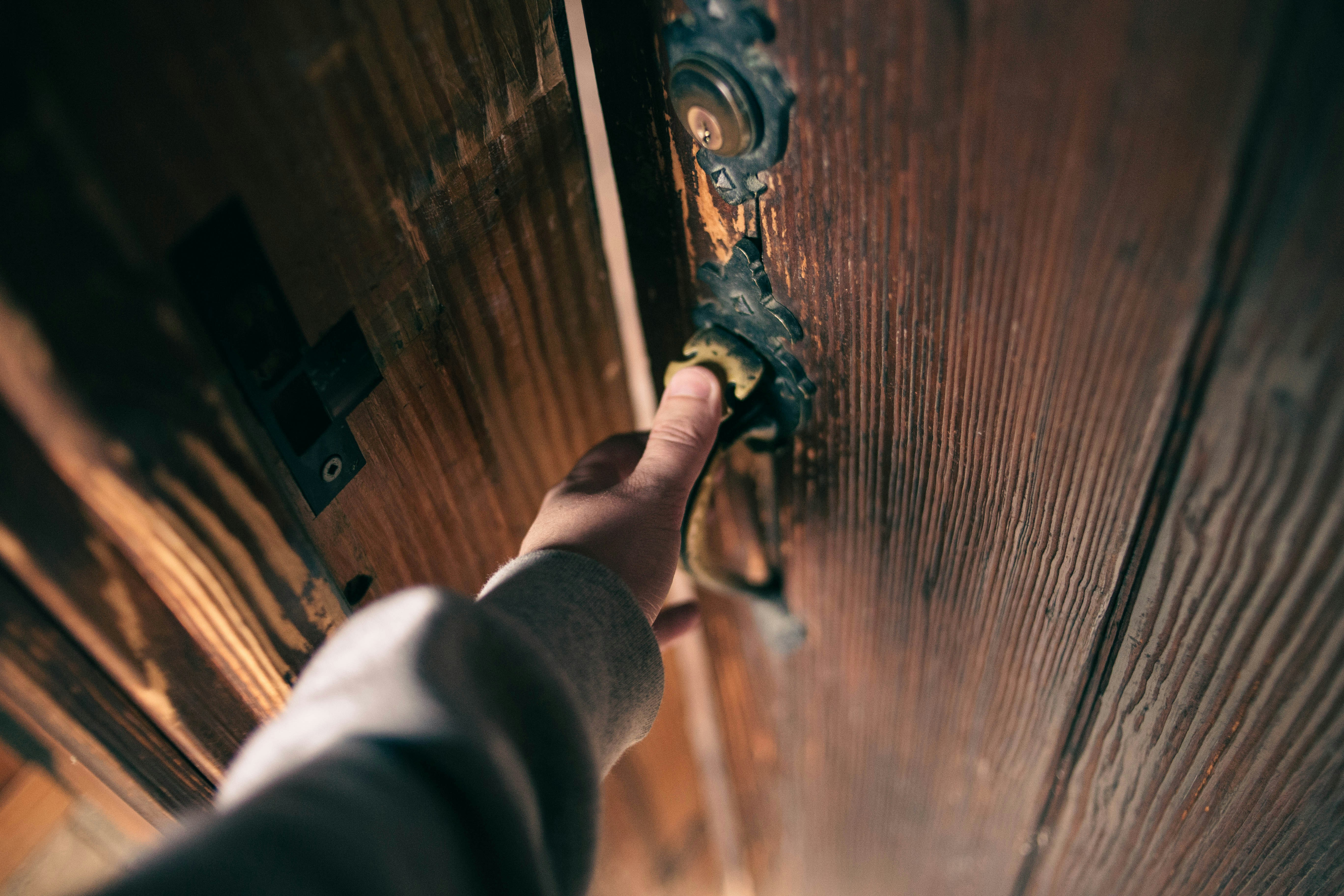 A person's hand reaching for a door handle photo – Free Human Image on ...