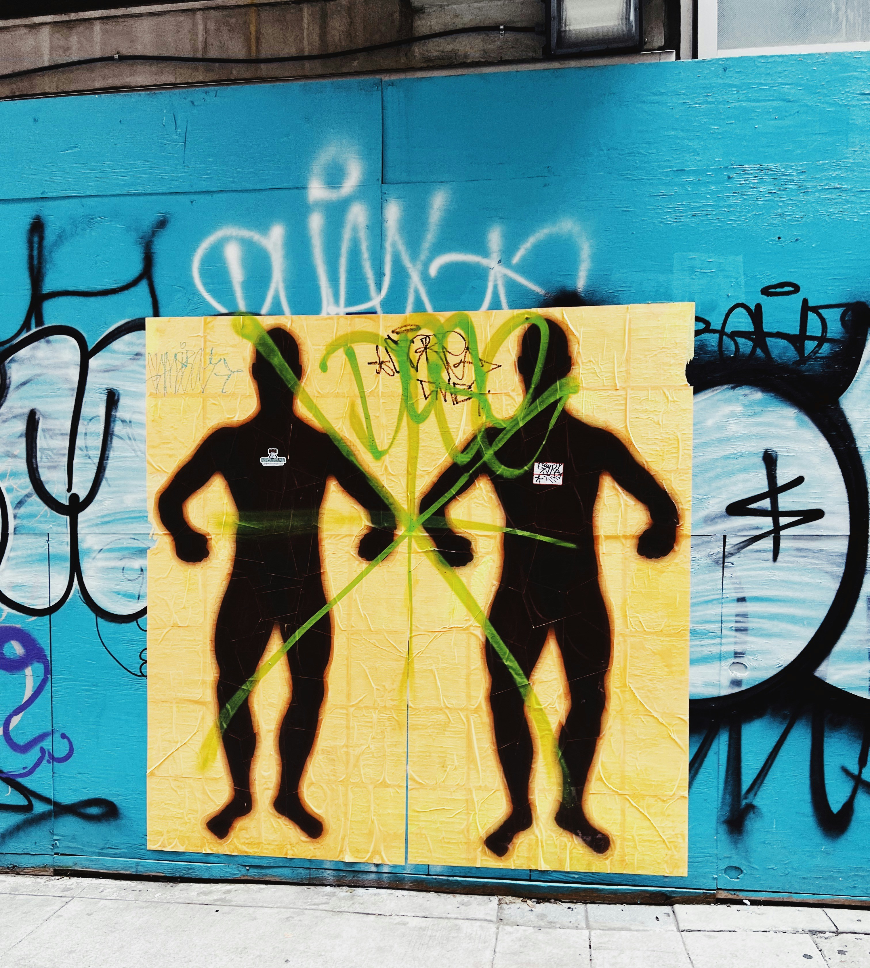 a blue wall with some graffiti on it